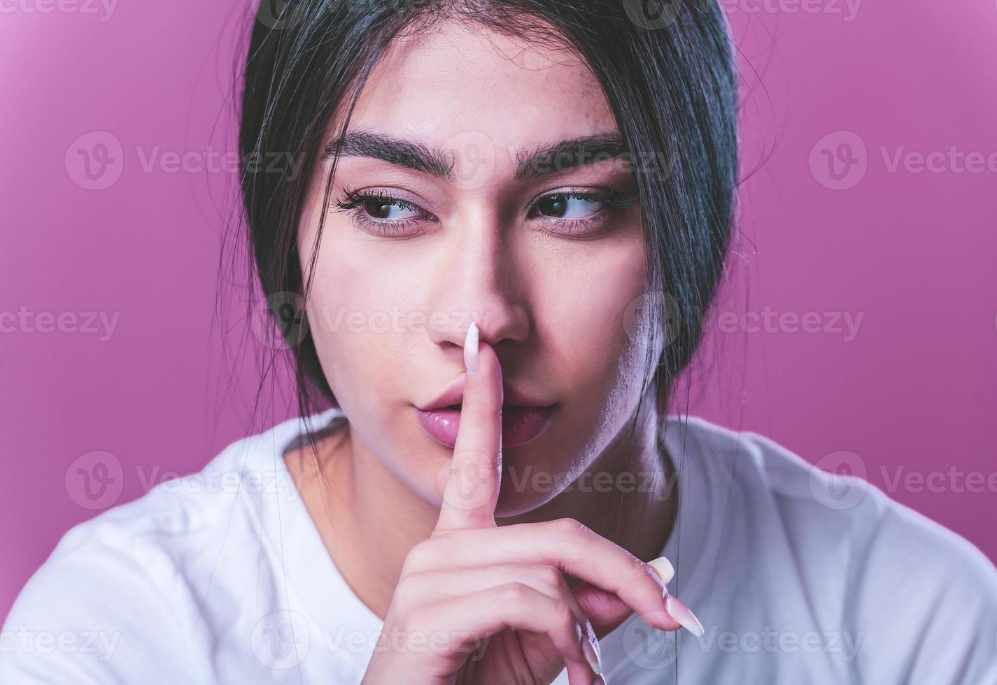 Photo of the creative expression of the silent woman. Brunette woman doing shhh sign 17011177 ...