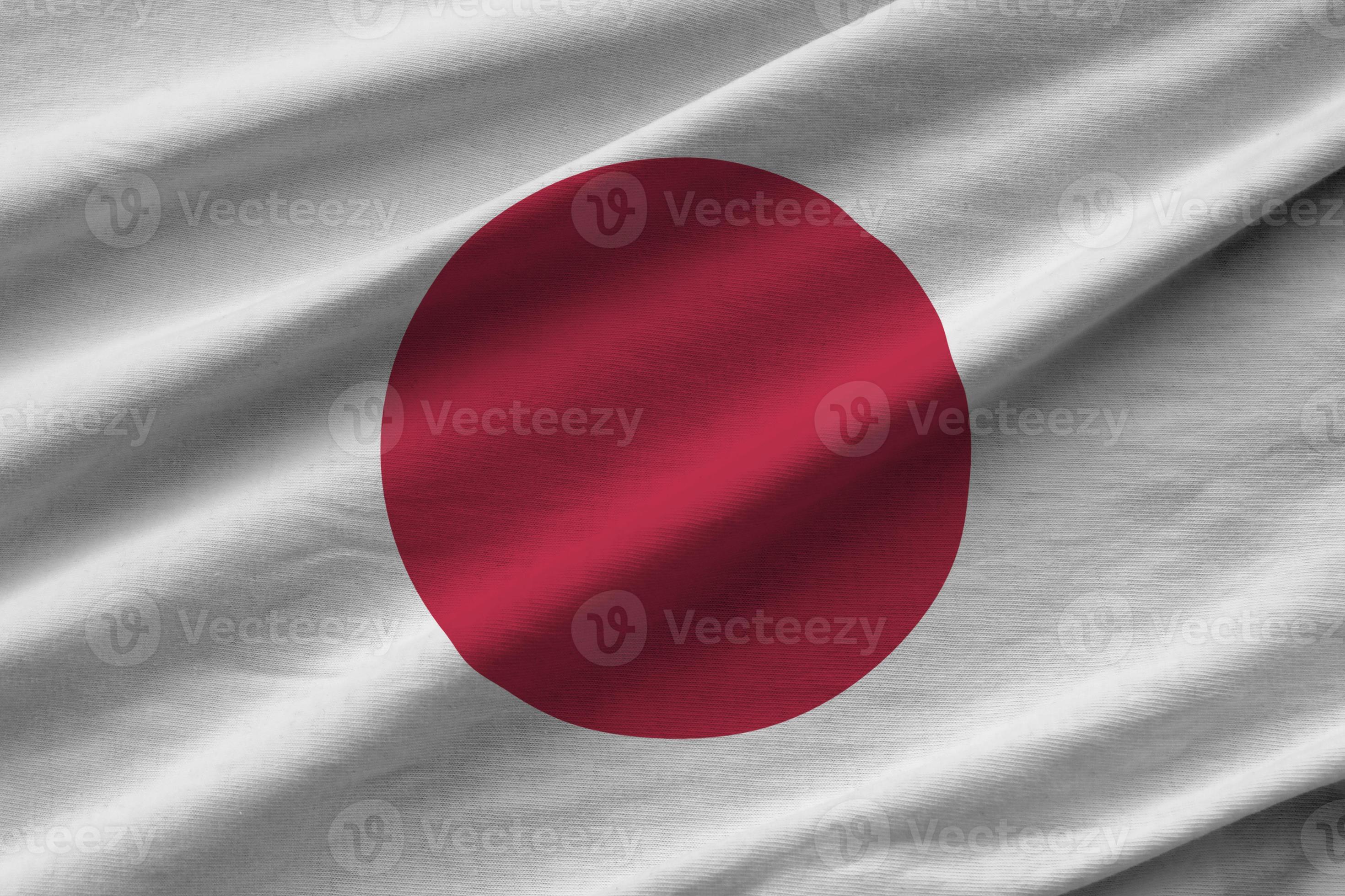 Japan flag with big folds waving close up under the studio light indoors. The official symbols ...