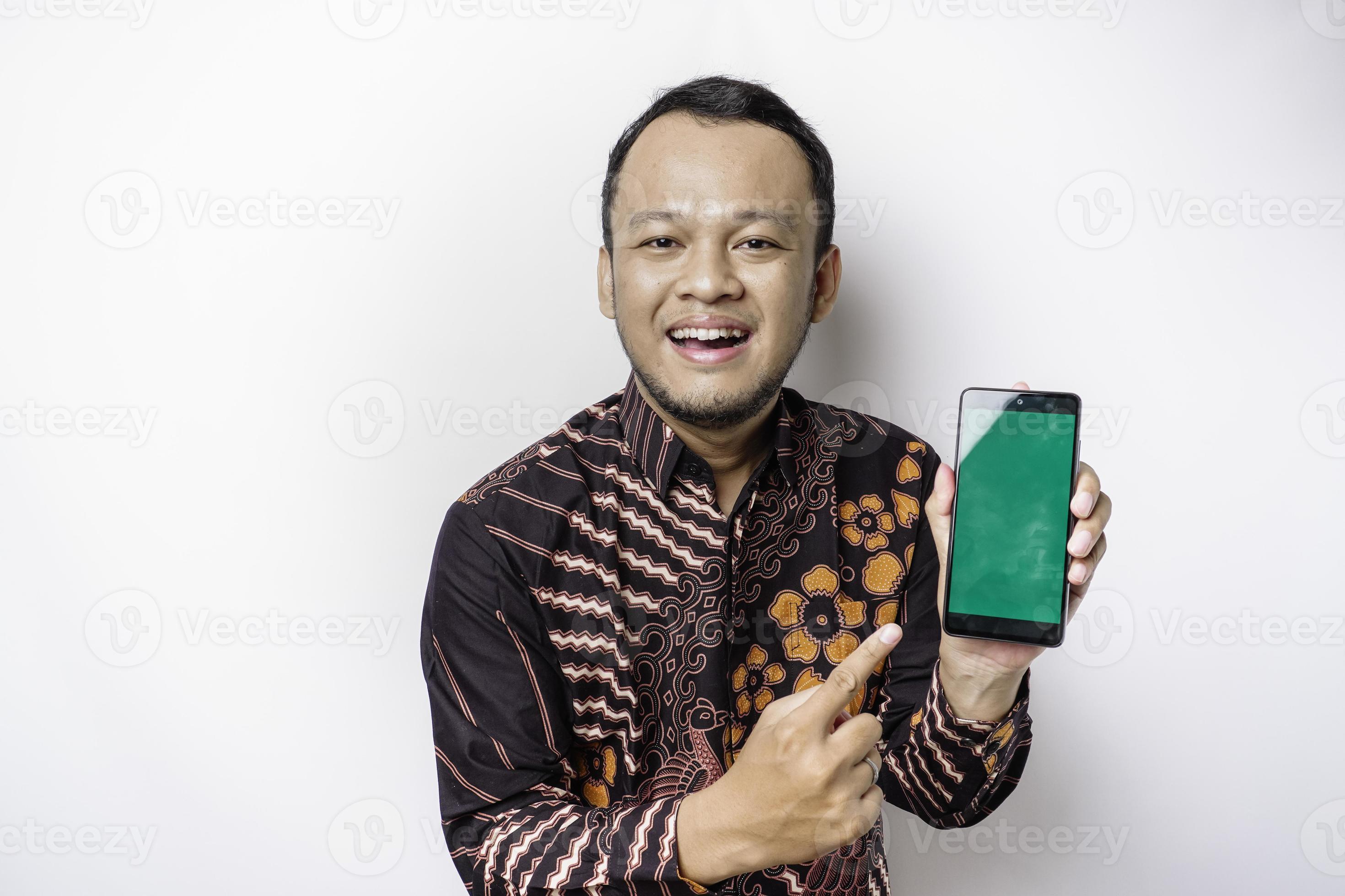 A portrait of a smiling Asian man wearing a batik shirt and showing ...