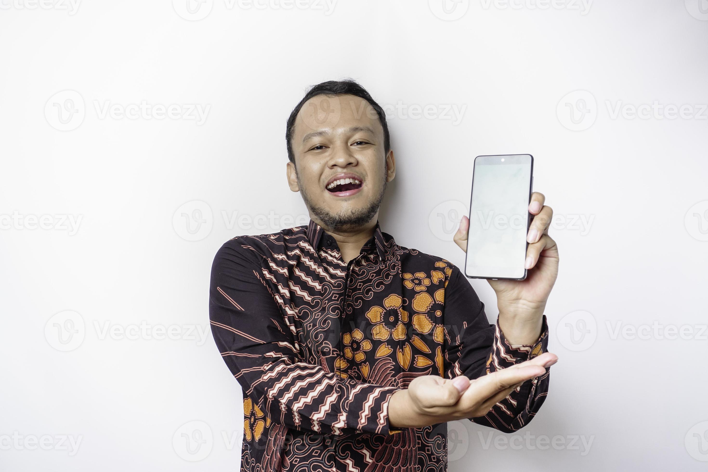 A portrait of a smiling Asian man wearing a batik shirt and showing ...