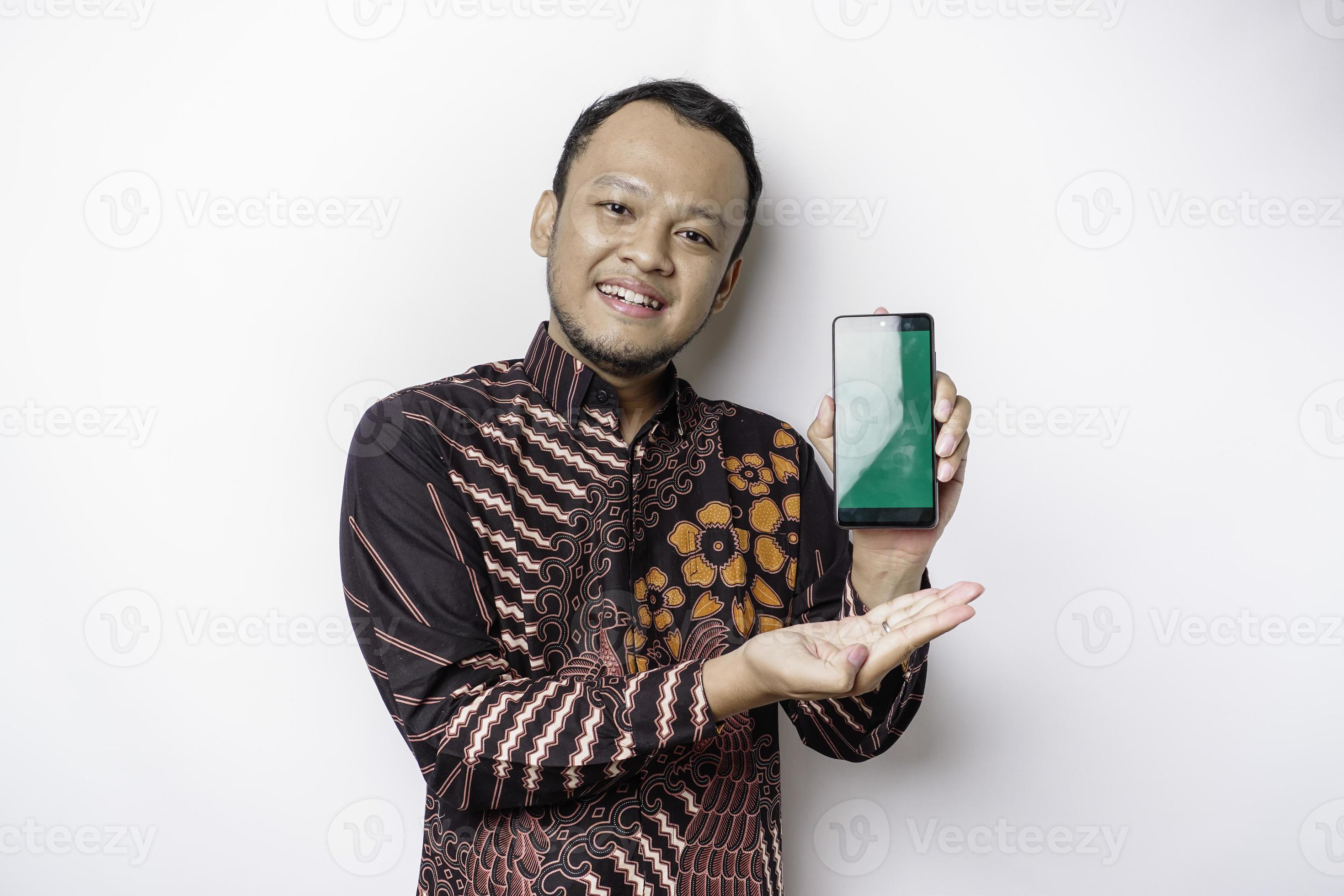 A portrait of a smiling Asian man wearing a batik shirt and showing ...