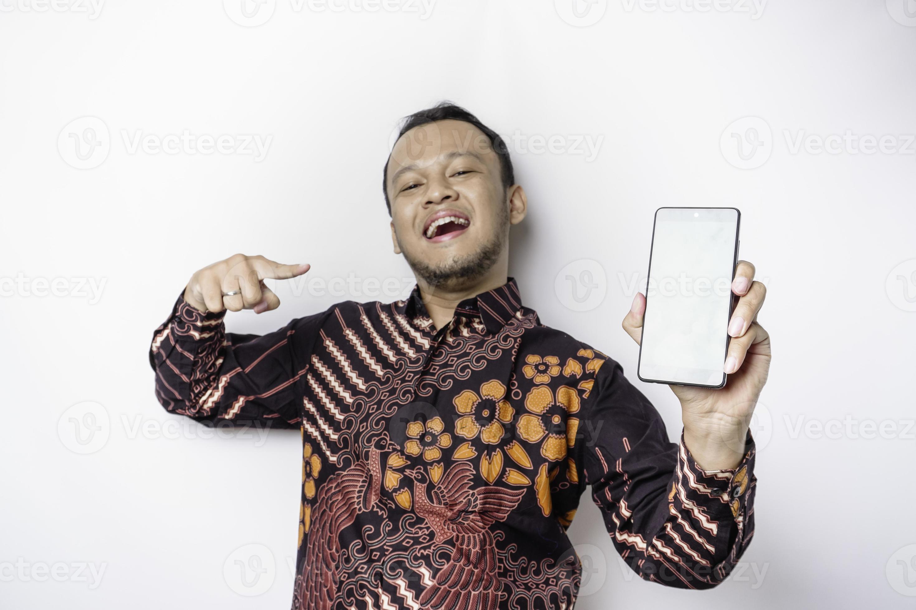 A portrait of a smiling Asian man wearing a batik shirt and showing ...