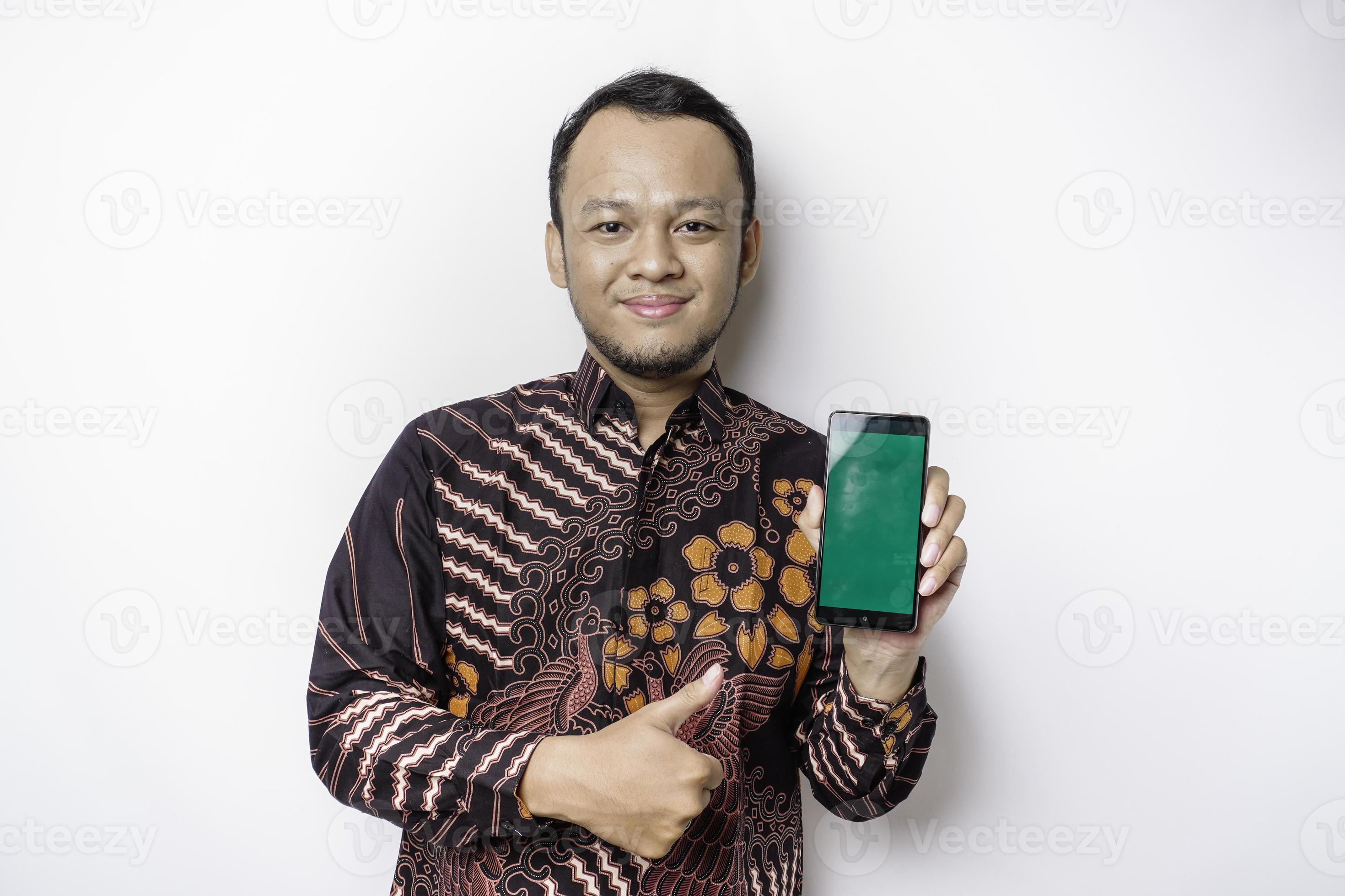 A portrait of a smiling Asian man wearing a batik shirt and showing ...