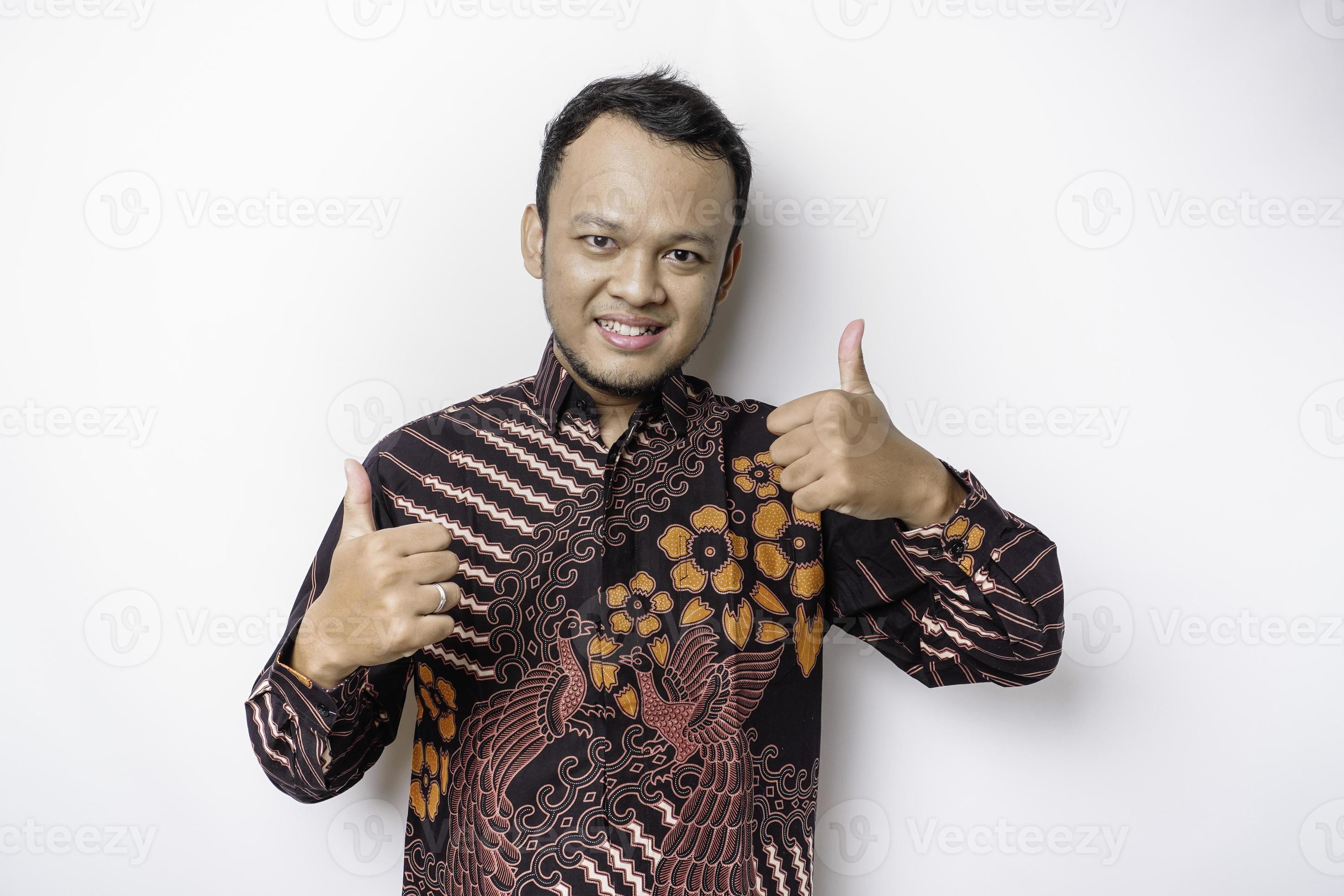 Excited Asian man wears batik shirt, gives thumbs up hand gesture of ...
