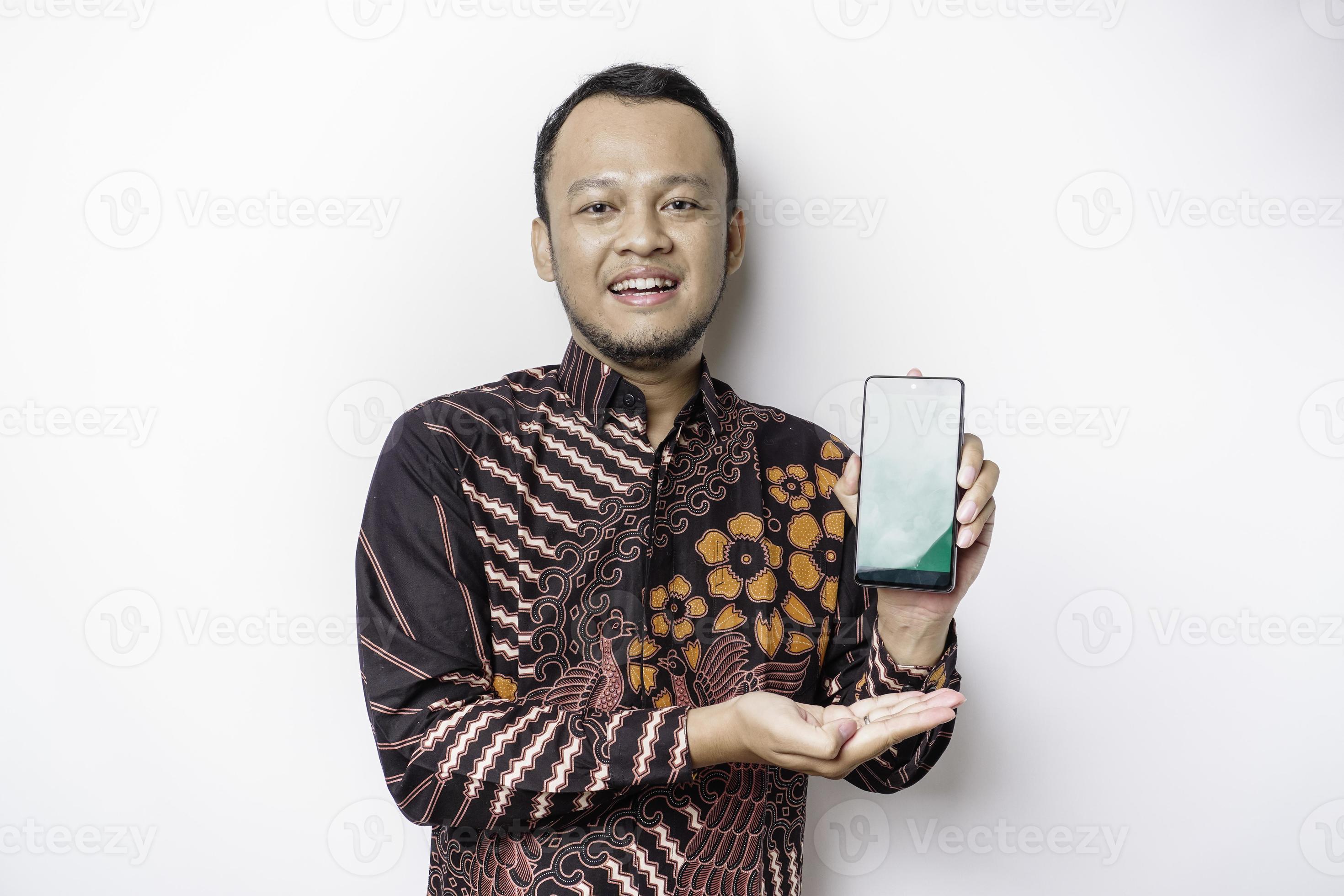 A portrait of a smiling Asian man wearing a batik shirt and showing ...