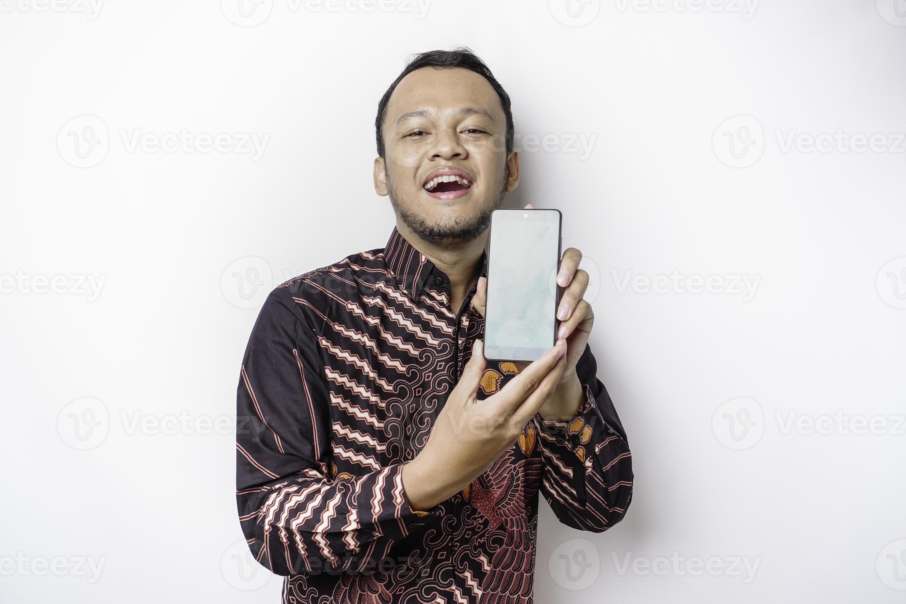 A portrait of a smiling Asian man wearing a batik shirt and showing ...