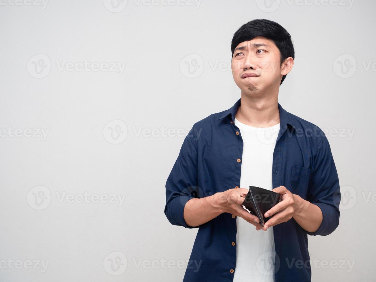 Poor asian man holding empty wallet feels sad looking at copy space 17073214 Stock Photo at Vecteezy
