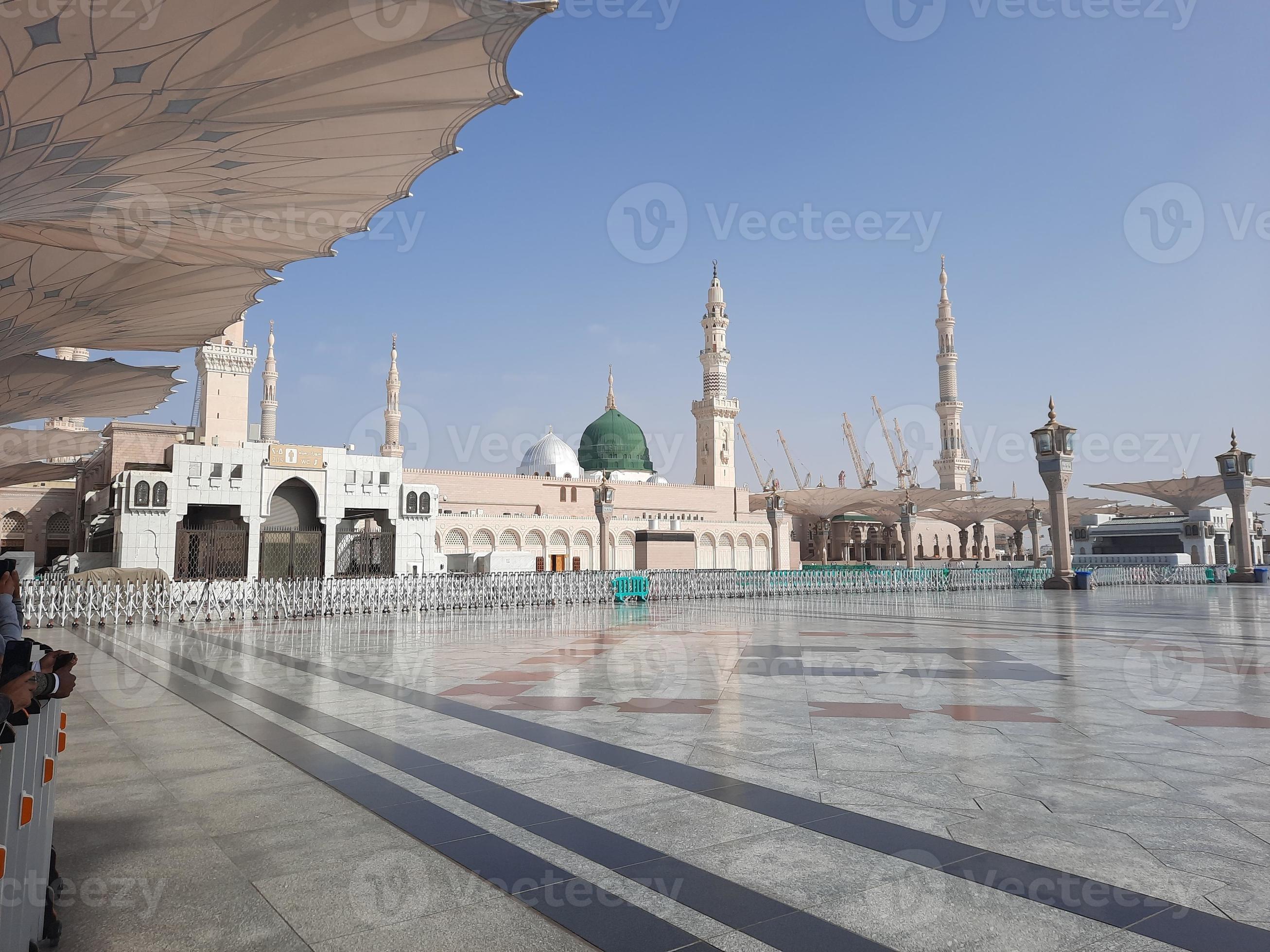 Beautiful daytime view of Masjid Al Nabawi, Medina's green dome, minarets and mosque courtyard ...