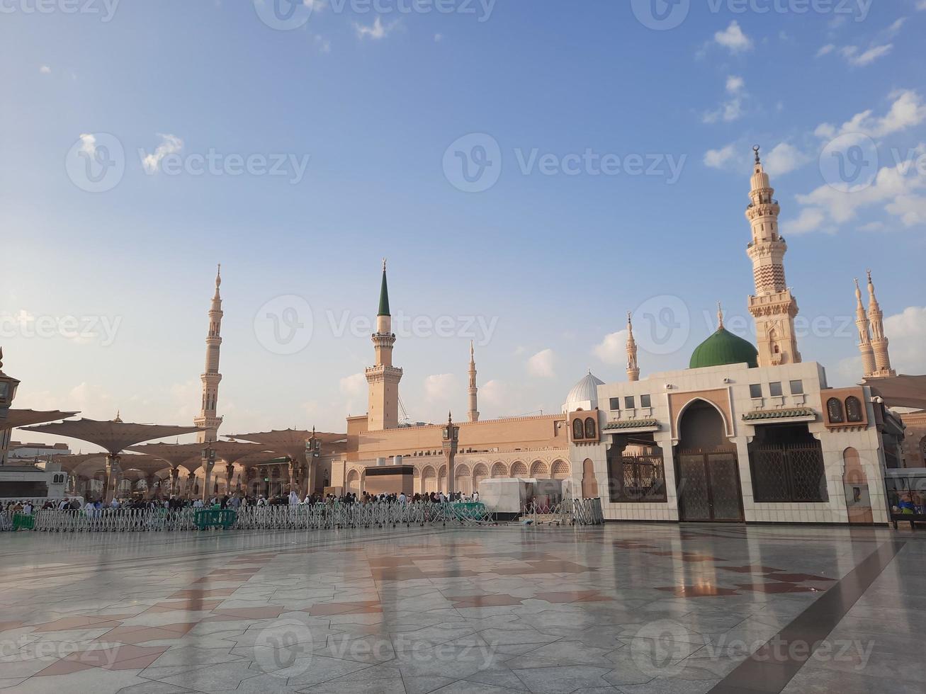 Beautiful daytime view of Masjid Al Nabawi, Medina's green dome, minarets and mosque courtyard ...