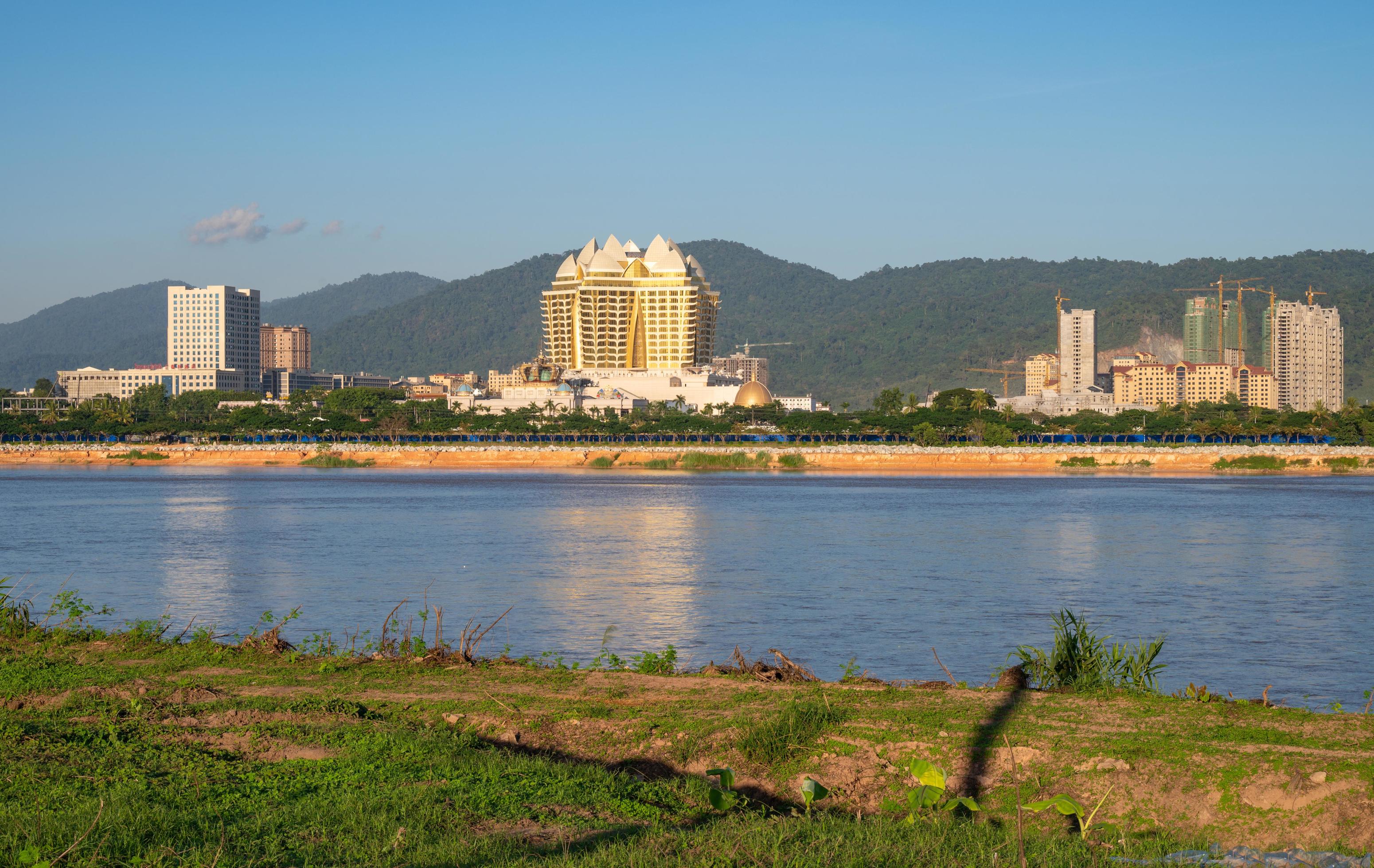 The large Casino and other buildings in Bokeo province in Laos view look through Mekong river ...