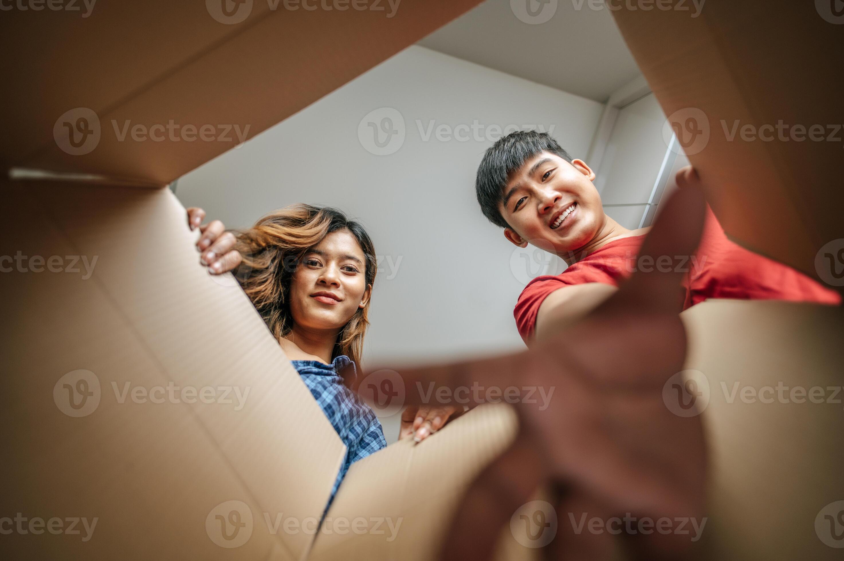 Young couple grabbing out of box Inside of package view 17324481 Stock ...