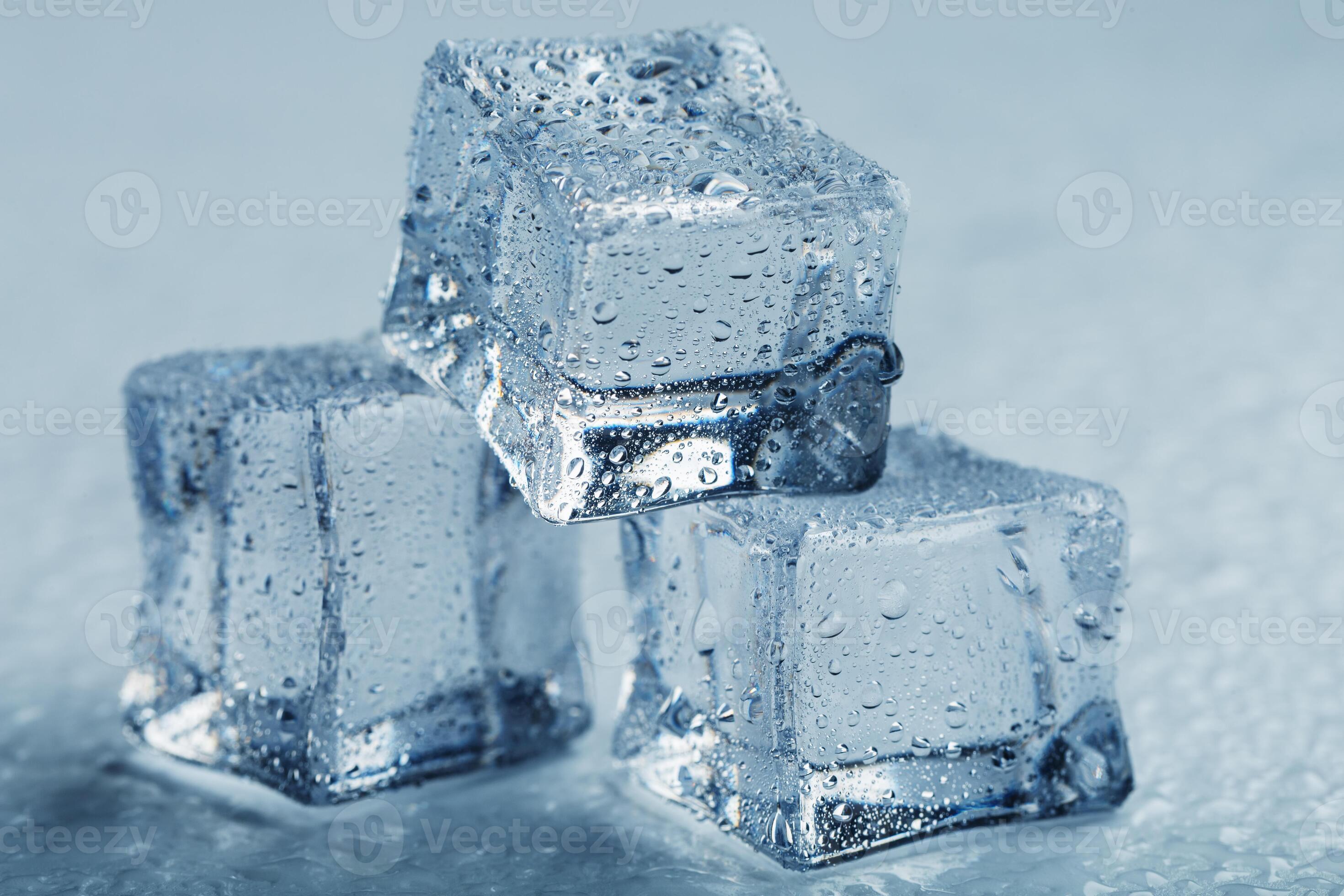 Ice cubes in the form of a pyramid with water drops close - up in macro on a white background ...