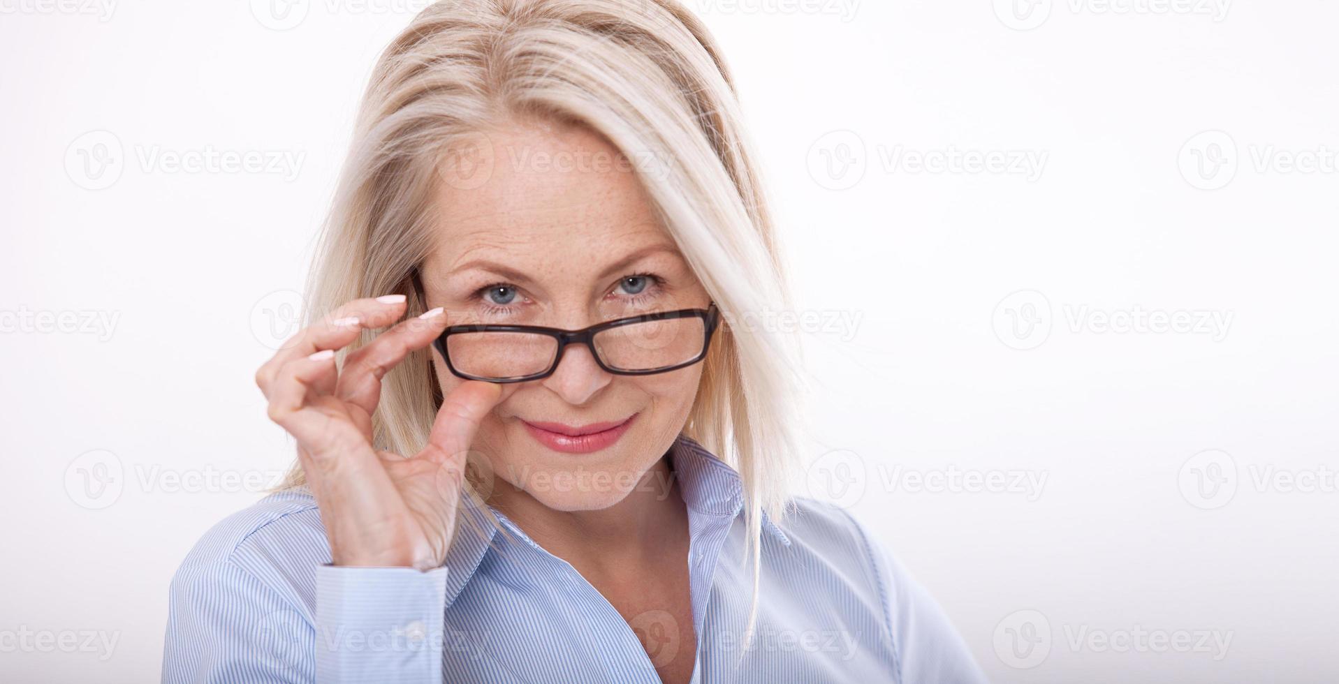 Middle aged business woman with eyeglasses in blue shirt isolated on ...