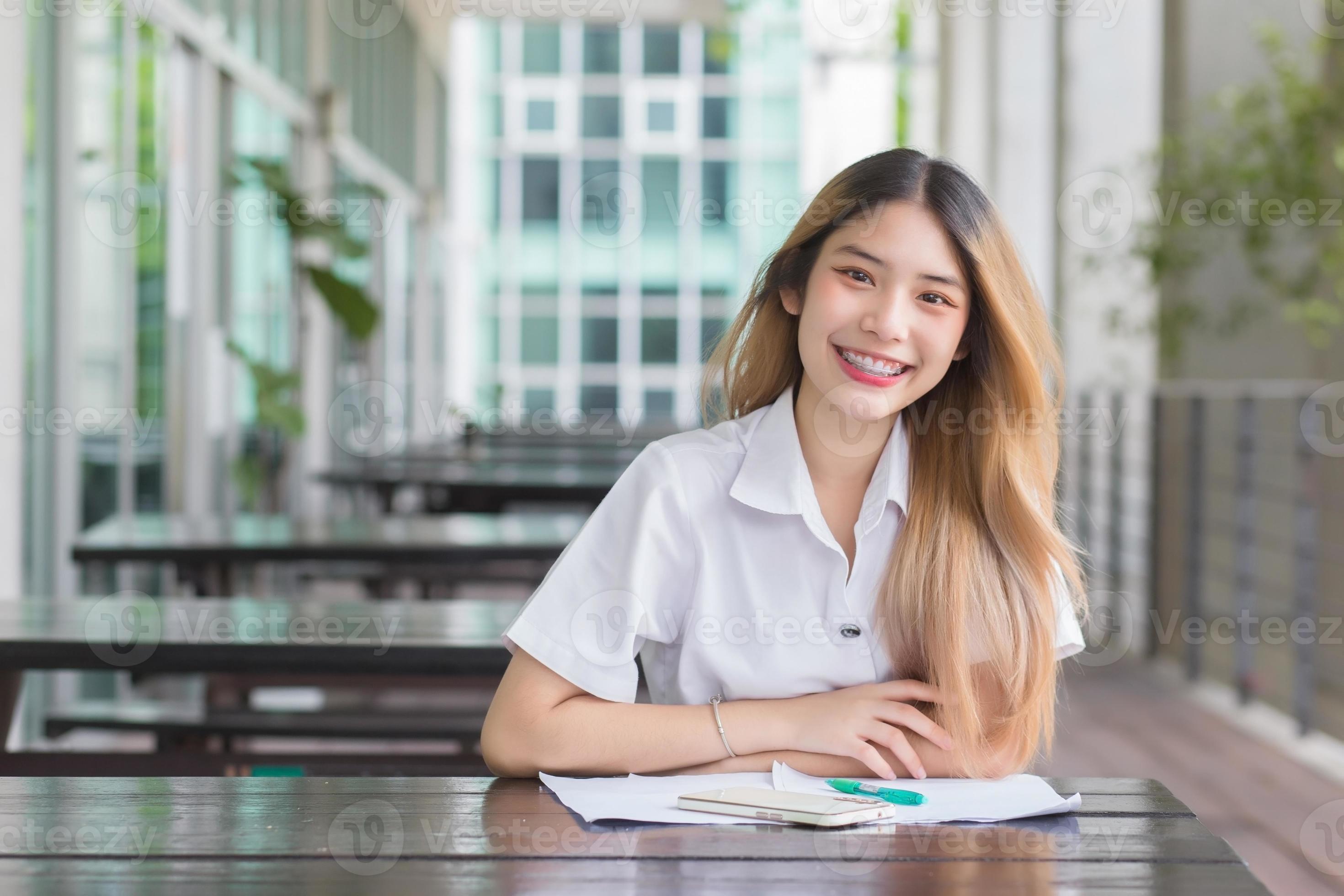 Young Asian girl student is using smart phone to search information for ...
