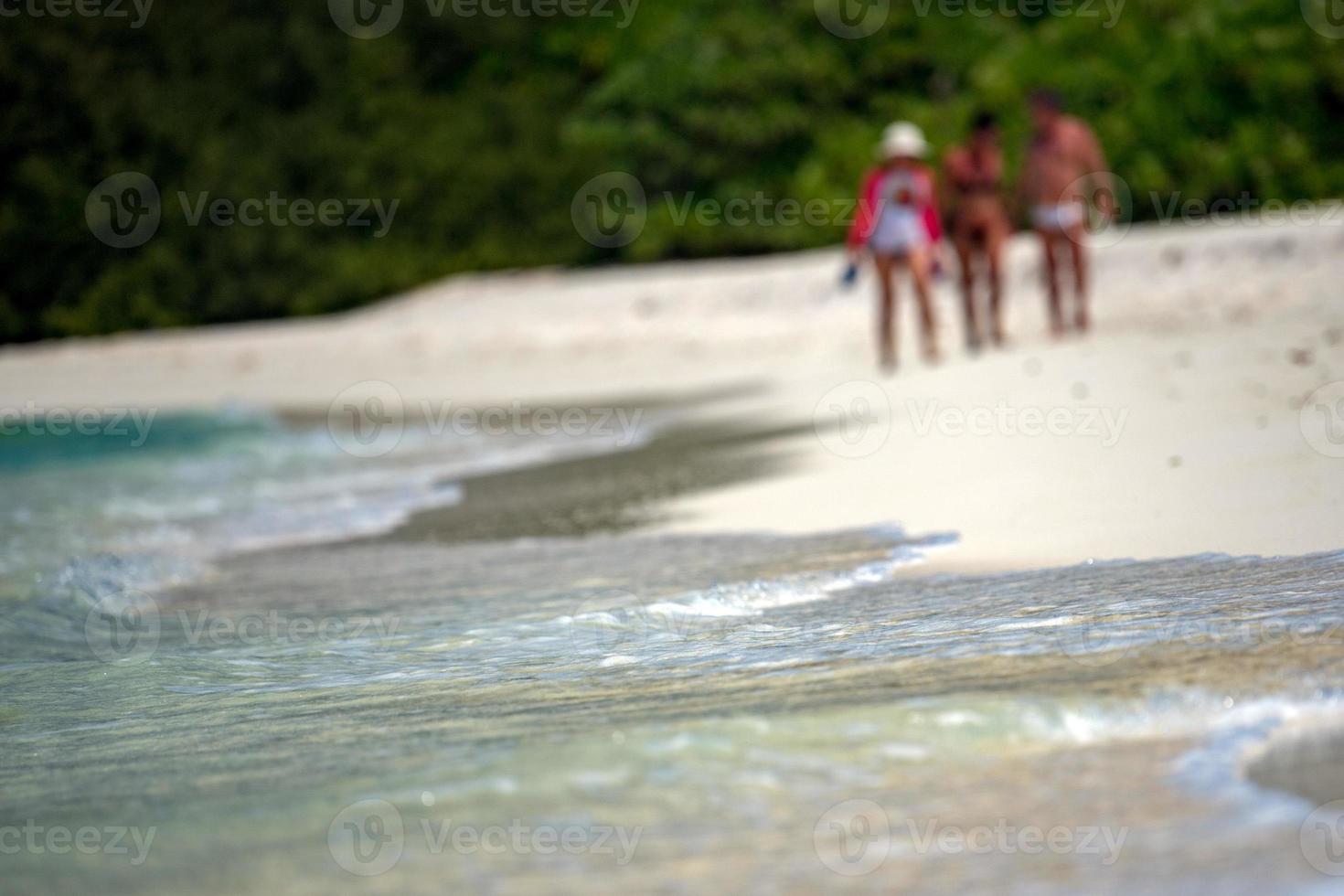 man and woman walking on polynesia beach 17417189 Stock Photo at Vecteezy