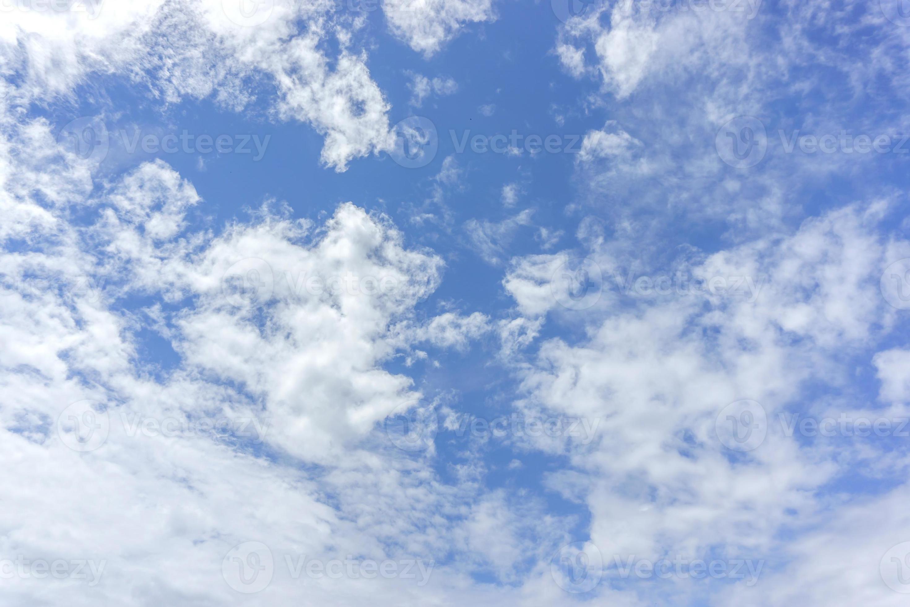 Background and texture of bright blue sky and cotton clouds with sun lights on afternoon summer ...