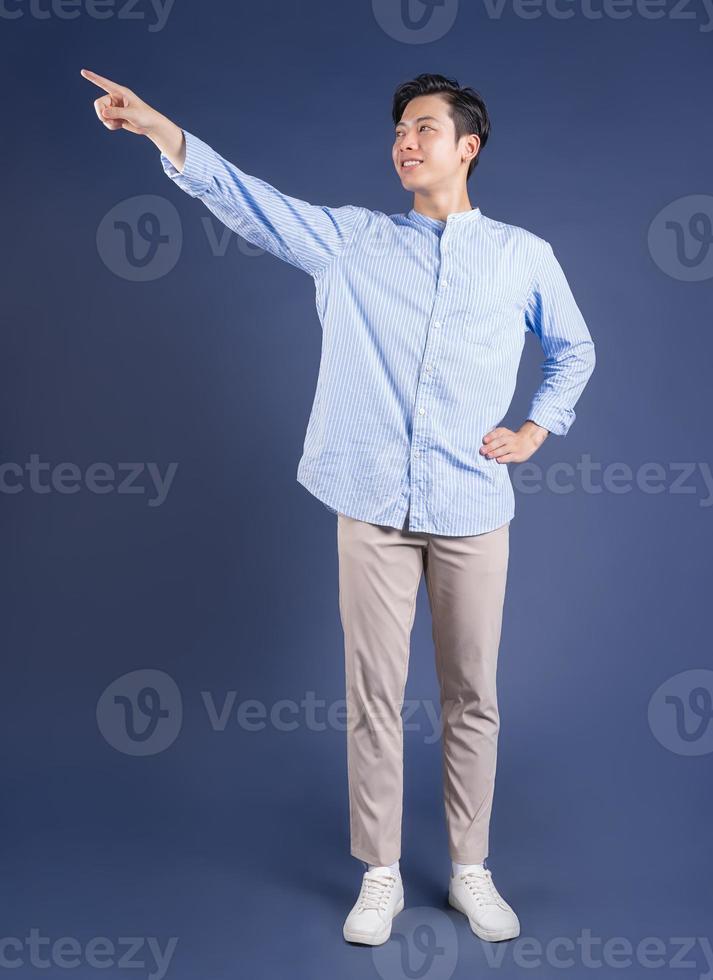 Young Asian man posing on background 17561201 Stock Photo at Vecteezy