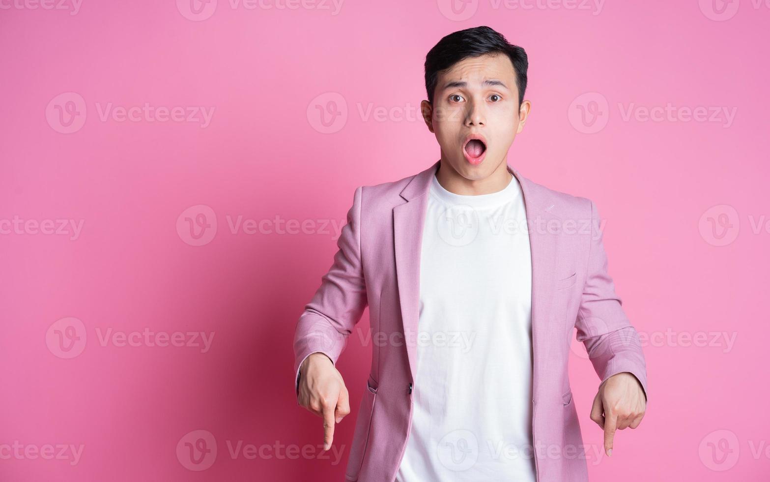 Portrait Of Young Asian Man Wearing Pink Suit Posing On Background