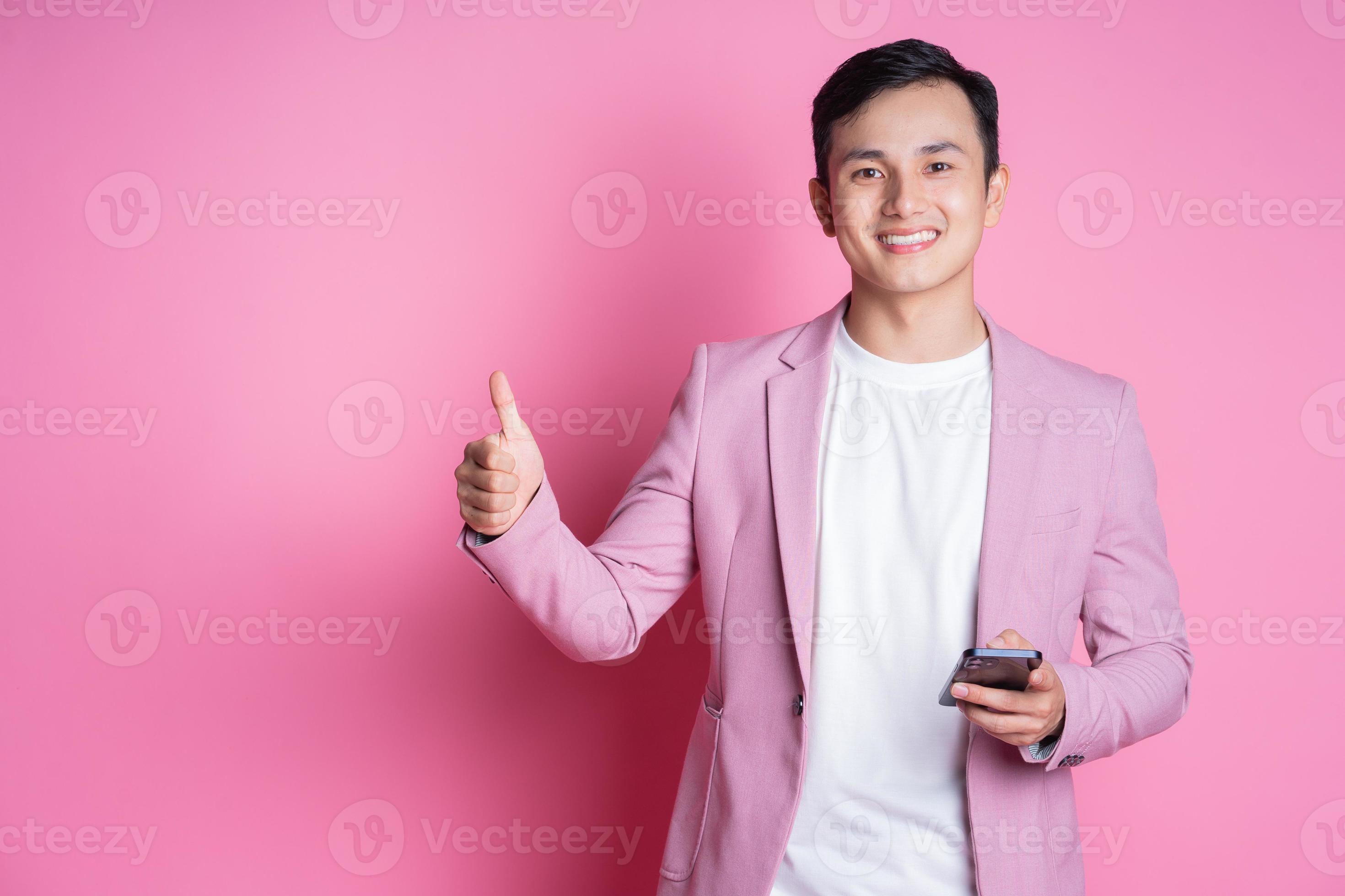 Portrait Of Young Asian Man Wearing Pink Suit Posing On Background