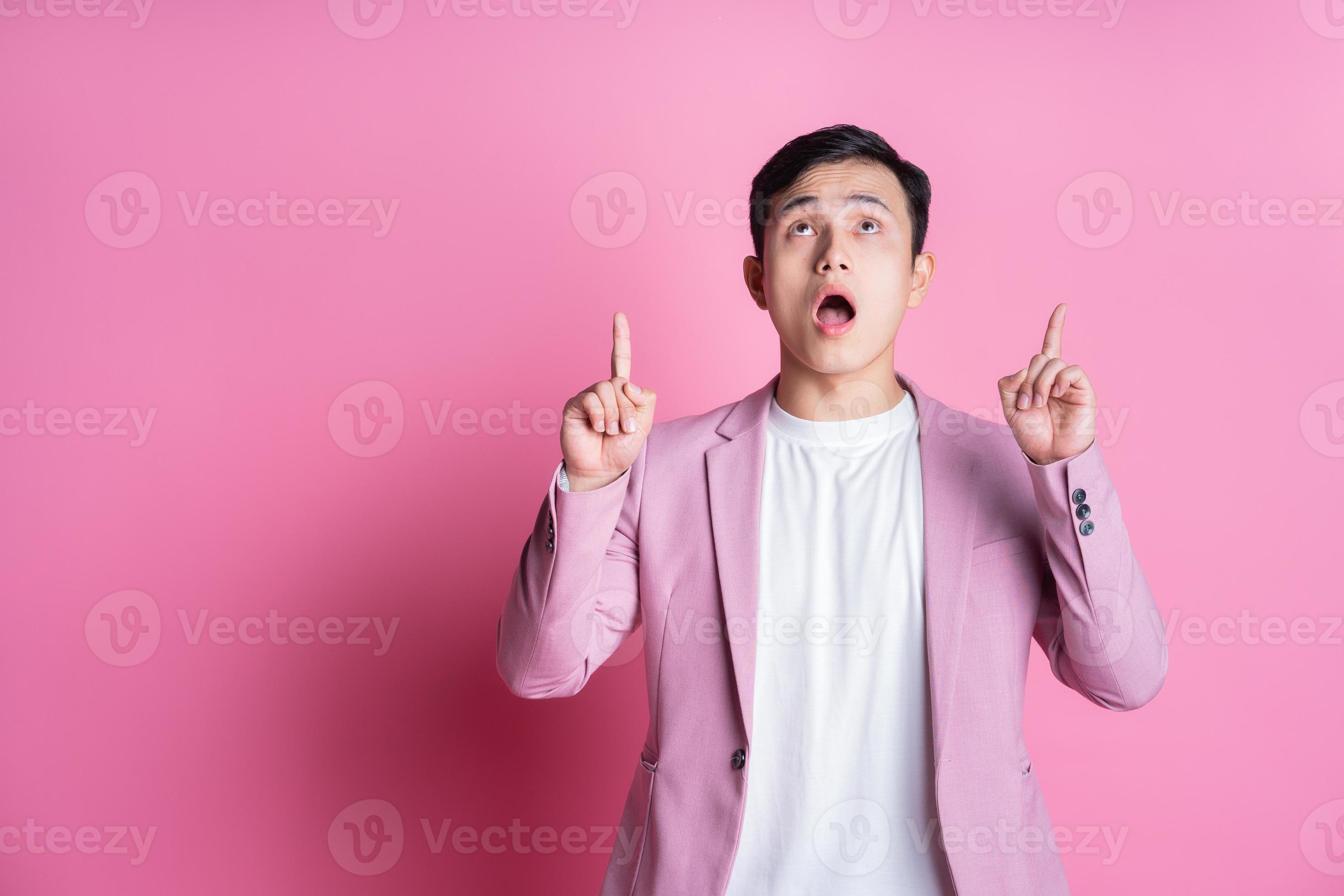 Portrait Of Young Asian Man Wearing Pink Suit Posing On Background