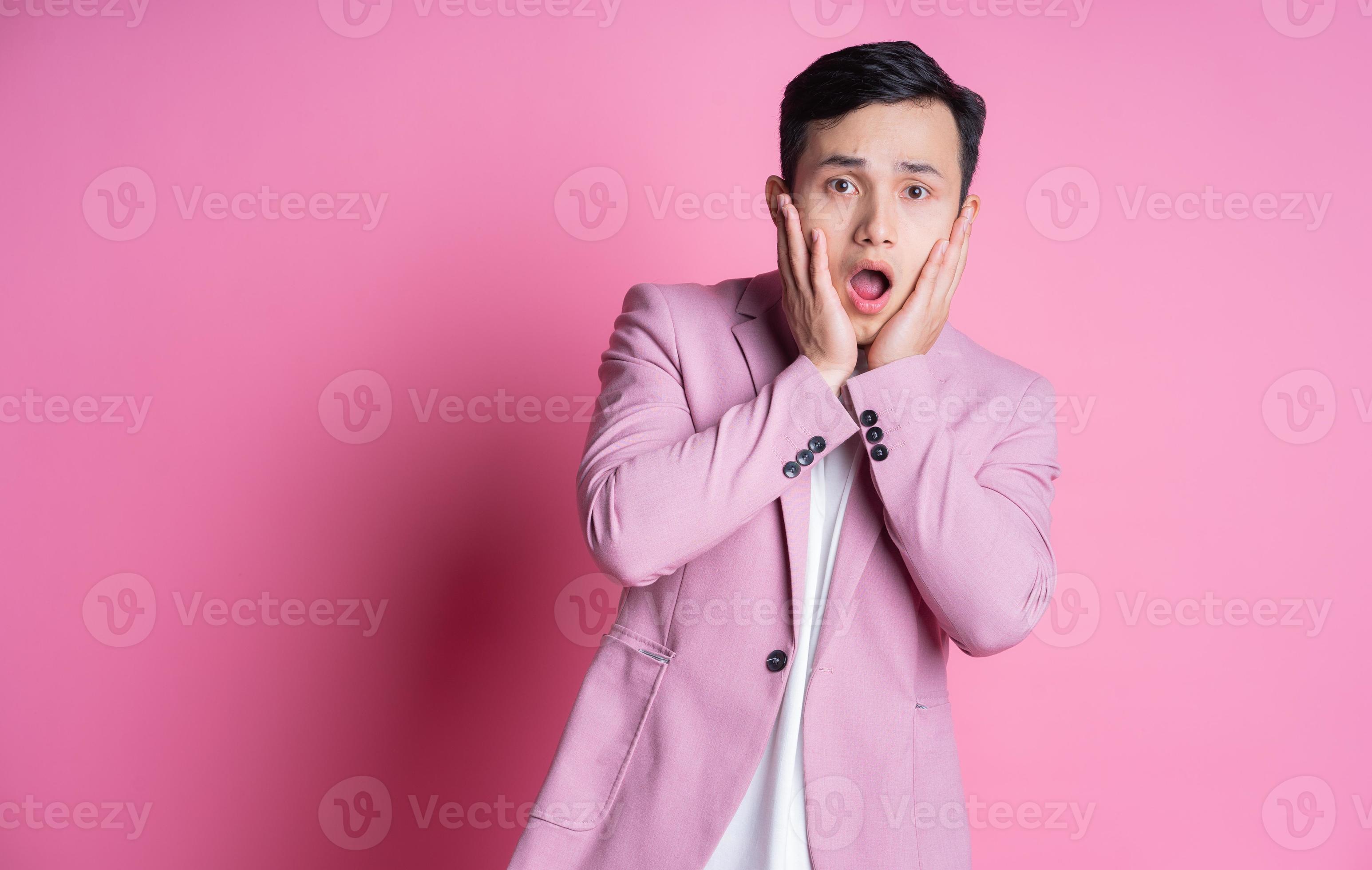 Portrait Of Young Asian Man Wearing Pink Suit Posing On Background