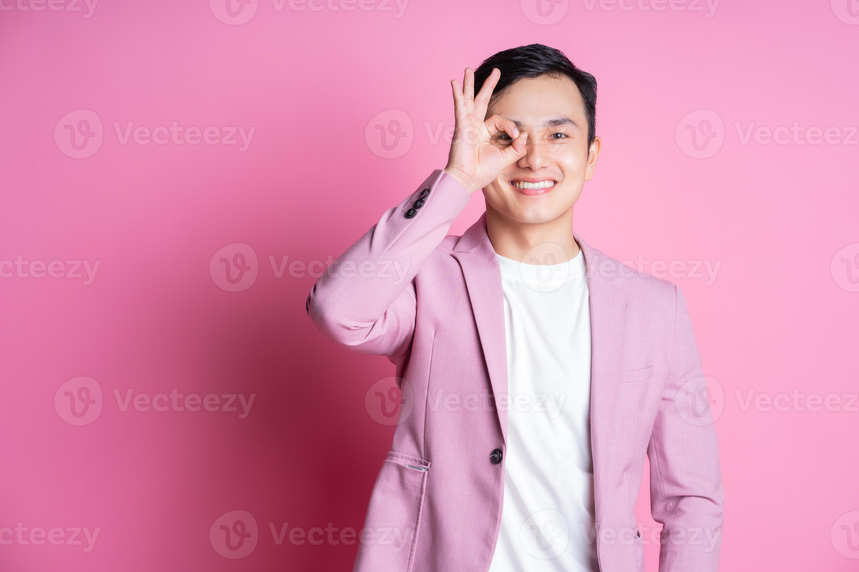 Portrait Of Young Asian Man Wearing Pink Suit Posing On Background