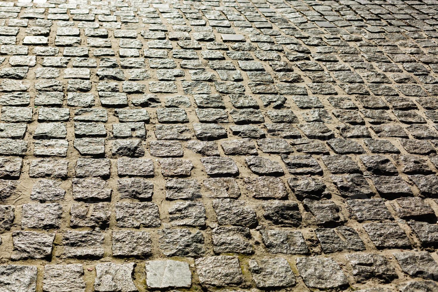 Black Cobbled Stone Road Background With Reflection Of Light Seen On