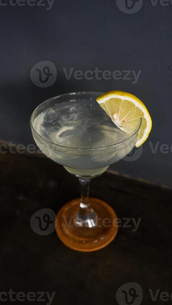 Lemonade. refreshing sparkling drink in an elegant glass garnished with a lemon wedge 17679992 ...