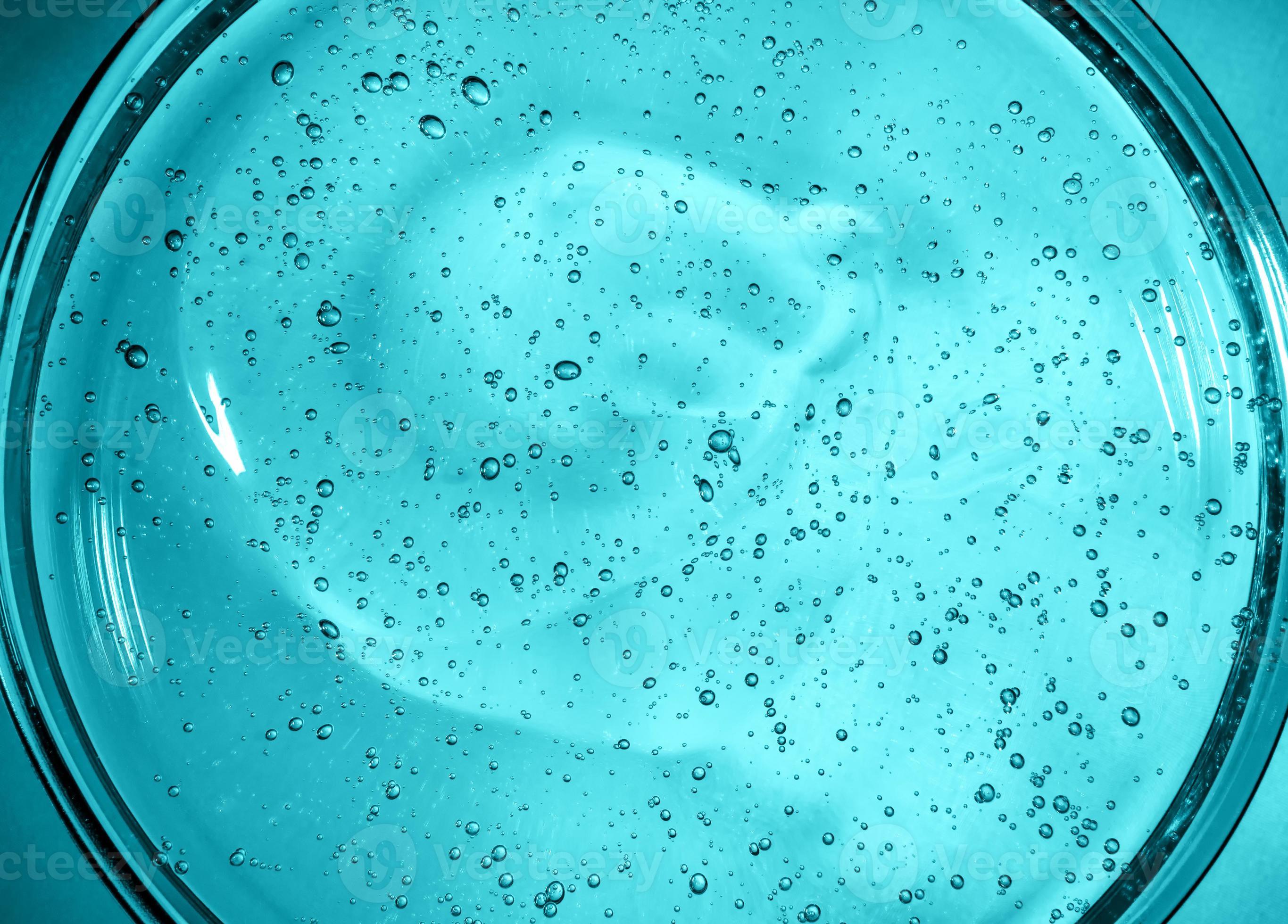 Gel with hyaluronic acid. Blue background with oxygen bubbles. Cosmetic gel in a petri dish ...