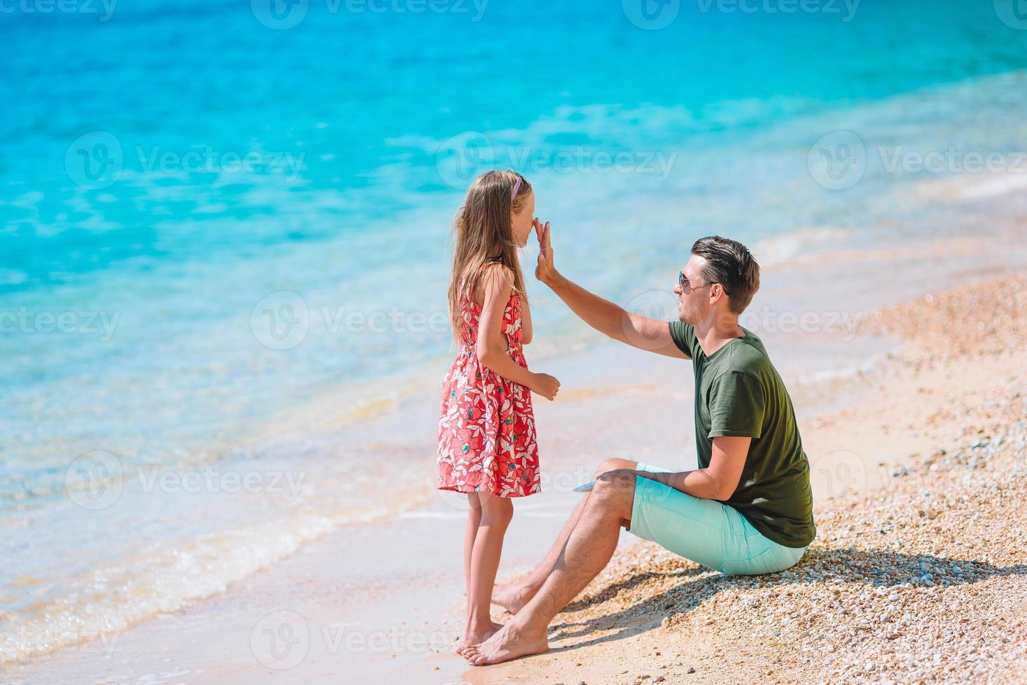 Father applying sun protection cream to his daughter at tropical beach 17704313 Stock Photo at ...