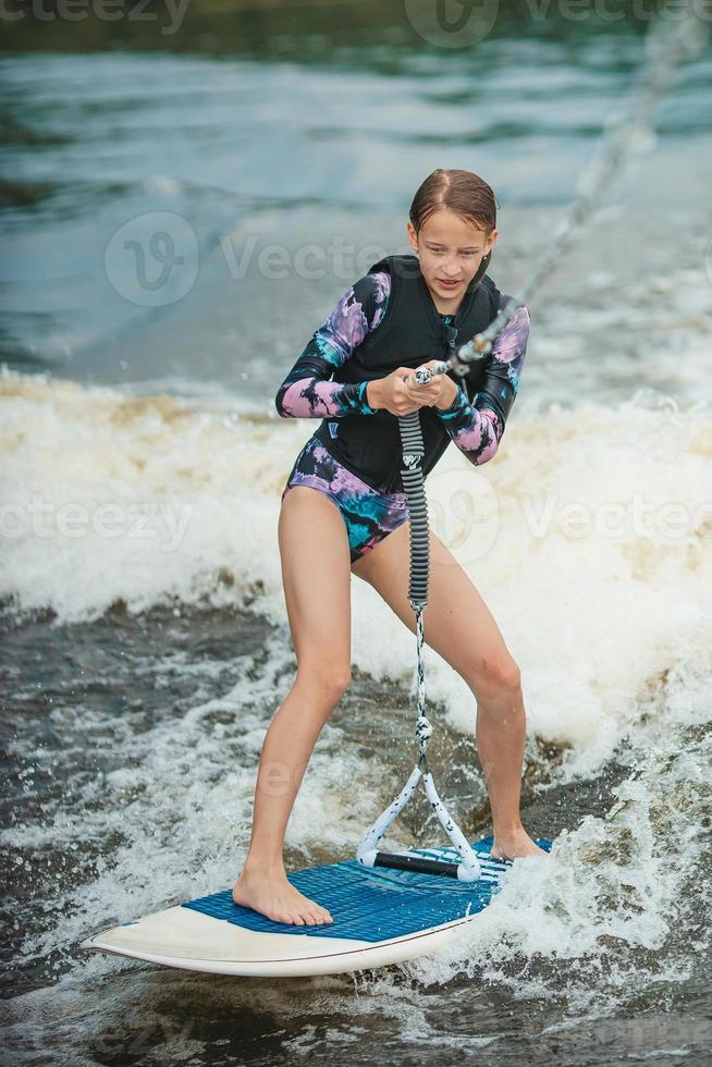 Active Beautiful Girl In The Swimsuit Standing On The Wakeboard In The