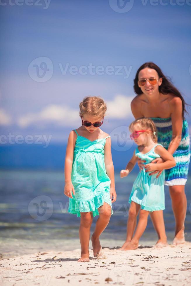 Young Mother And Two Her Daughters Have Fun At Exotic Beach On Sunny