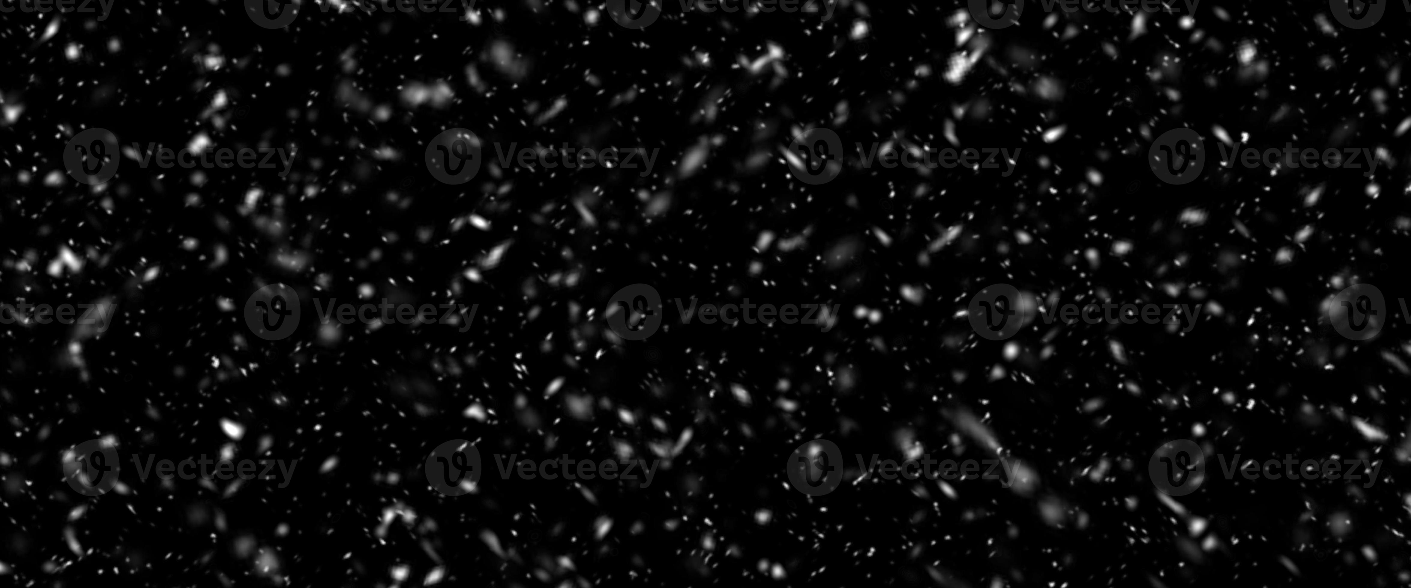 Falling snow flakes, Flying dust particles on a black background. Abstract winter background ...