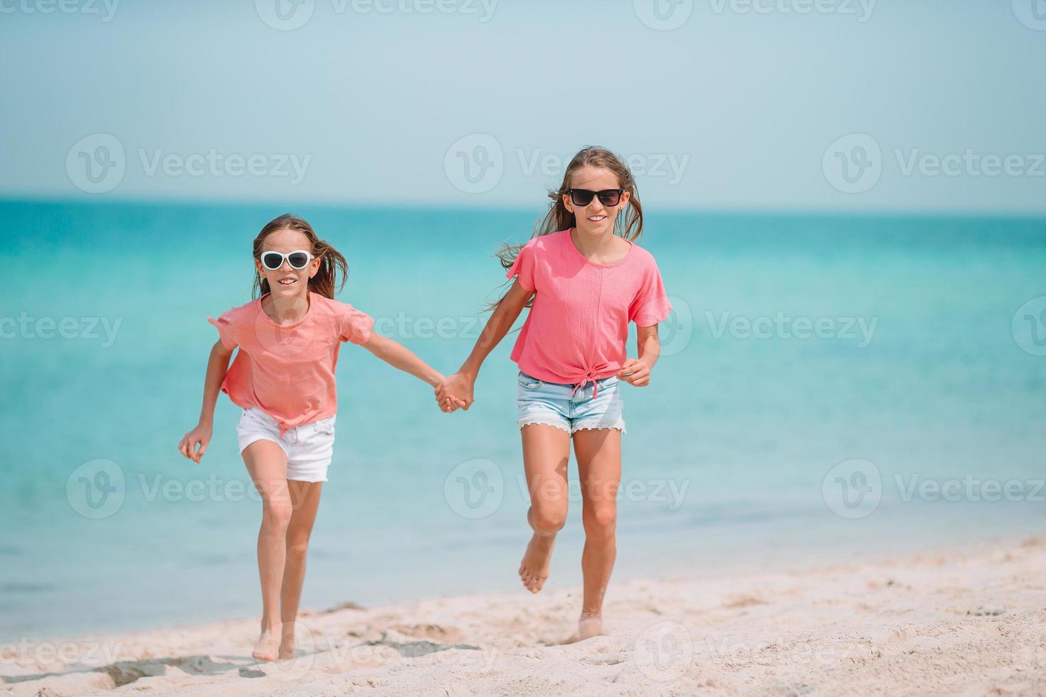 Adorable little girls having fun on the beach 18106085 Stock Photo at ... Adorable little girls having fun on the beach 18106085 Stock Photo at ...
