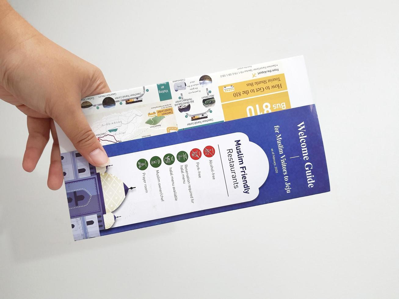 Jakarta, Indonesia in May 2022. A hand is holding a welcome guide book ...