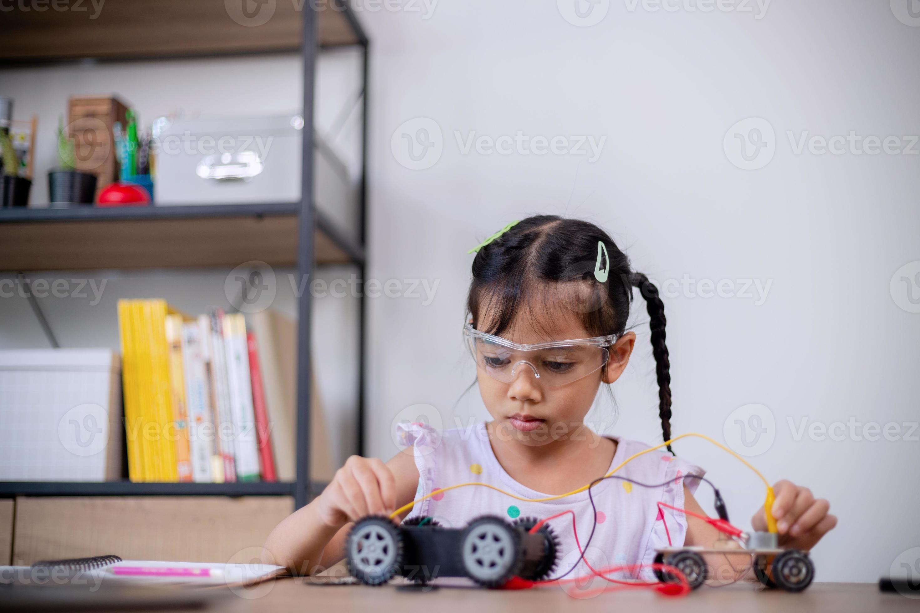 Asian students learn at home by coding robot cars and electronic board ...