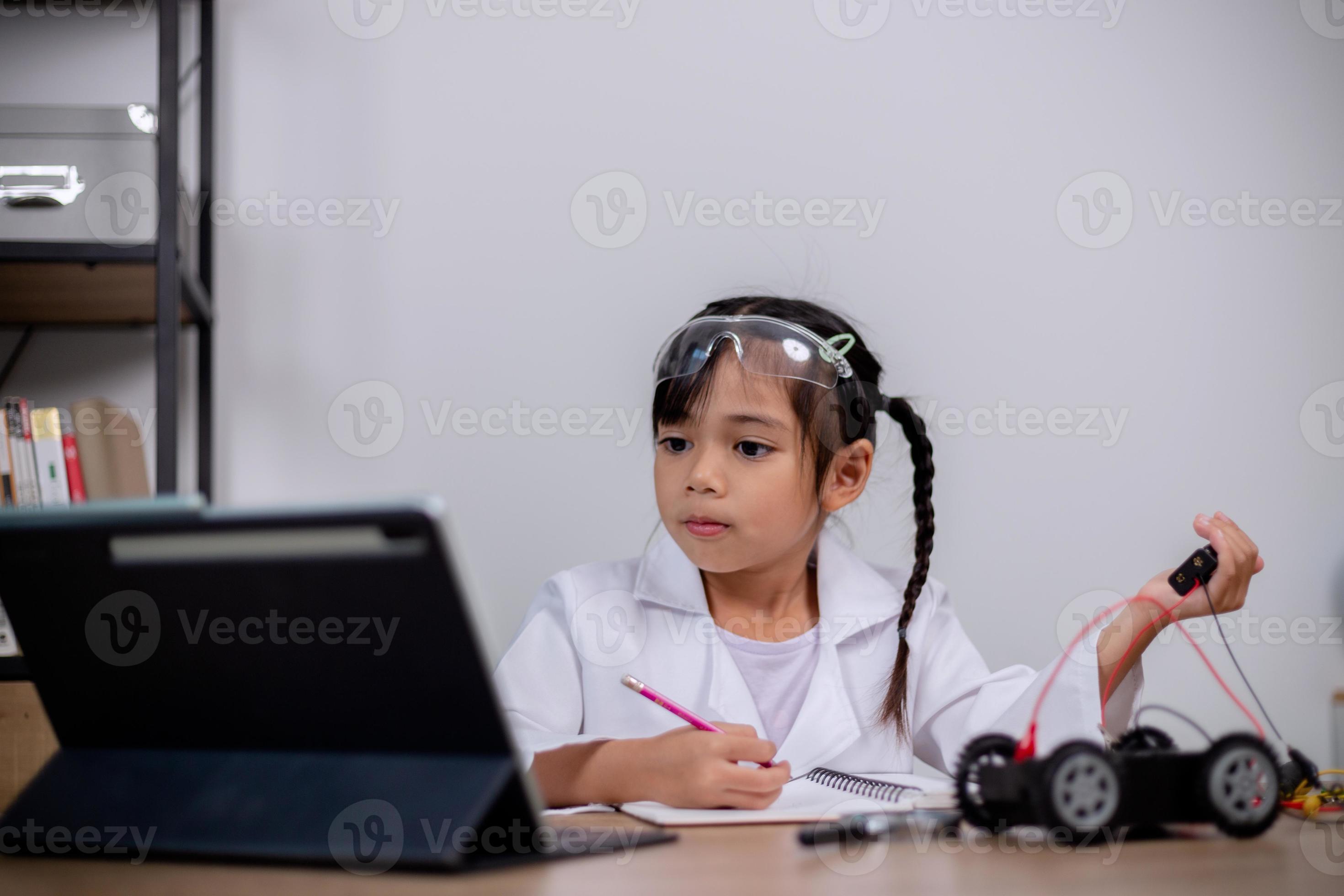 Asian students learn at home by coding robot cars and electronic board ...