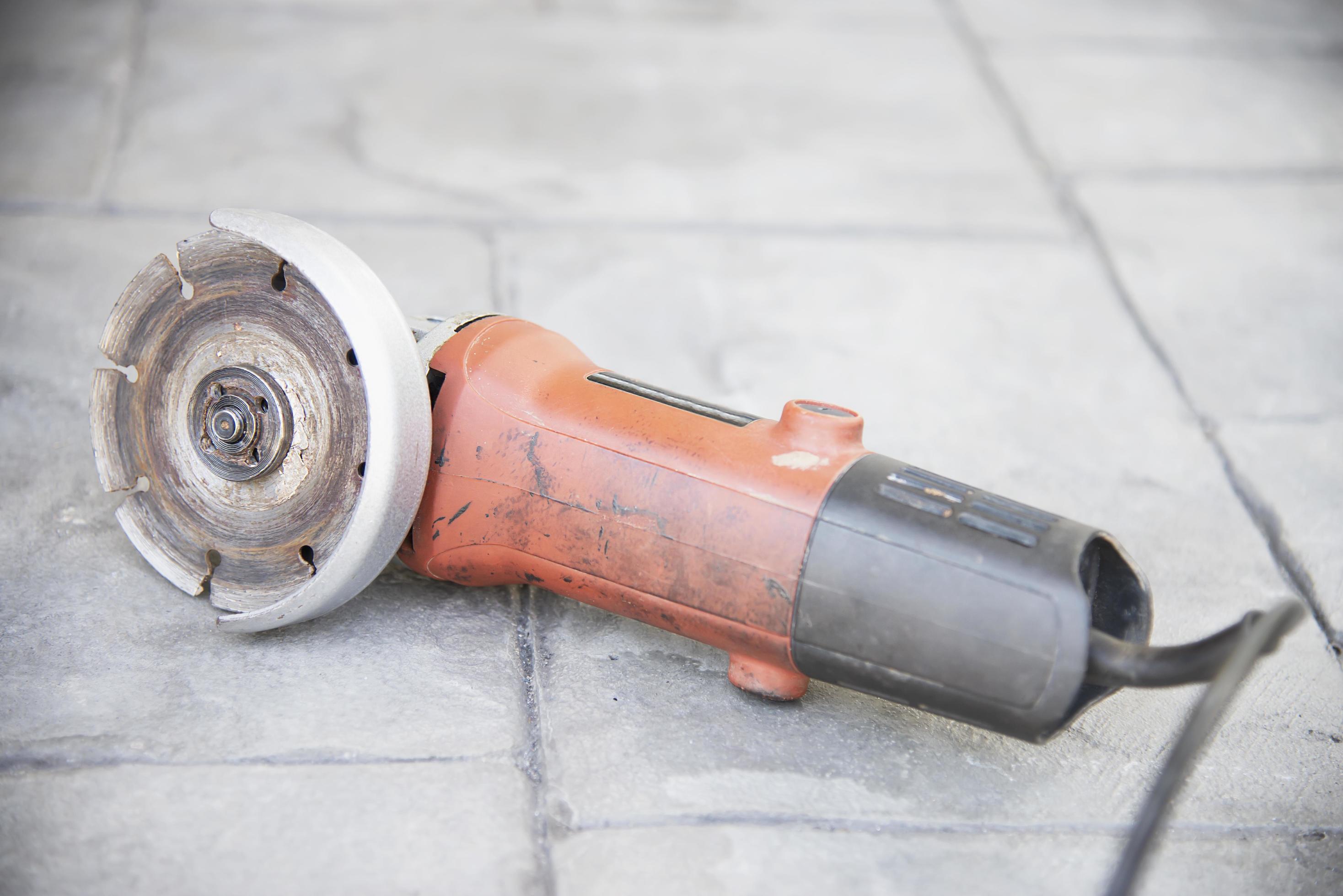 used electrical angle grinder on gray cement floor famous construction hand tool machine 18910543 Stock Photo at Vecteezy