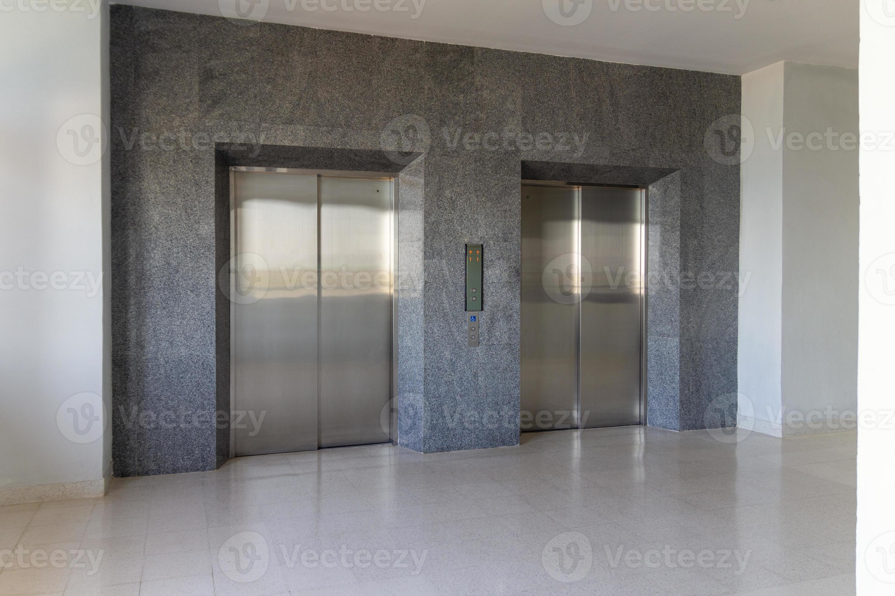 in front of an elevator inside a building where no one is queuing up to ...