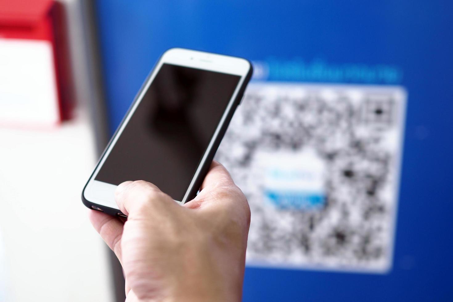 Hands use the phone to scan QR codes to receive discounts on purchases ... Hands use the phone to scan QR codes to receive discounts on purchases ...