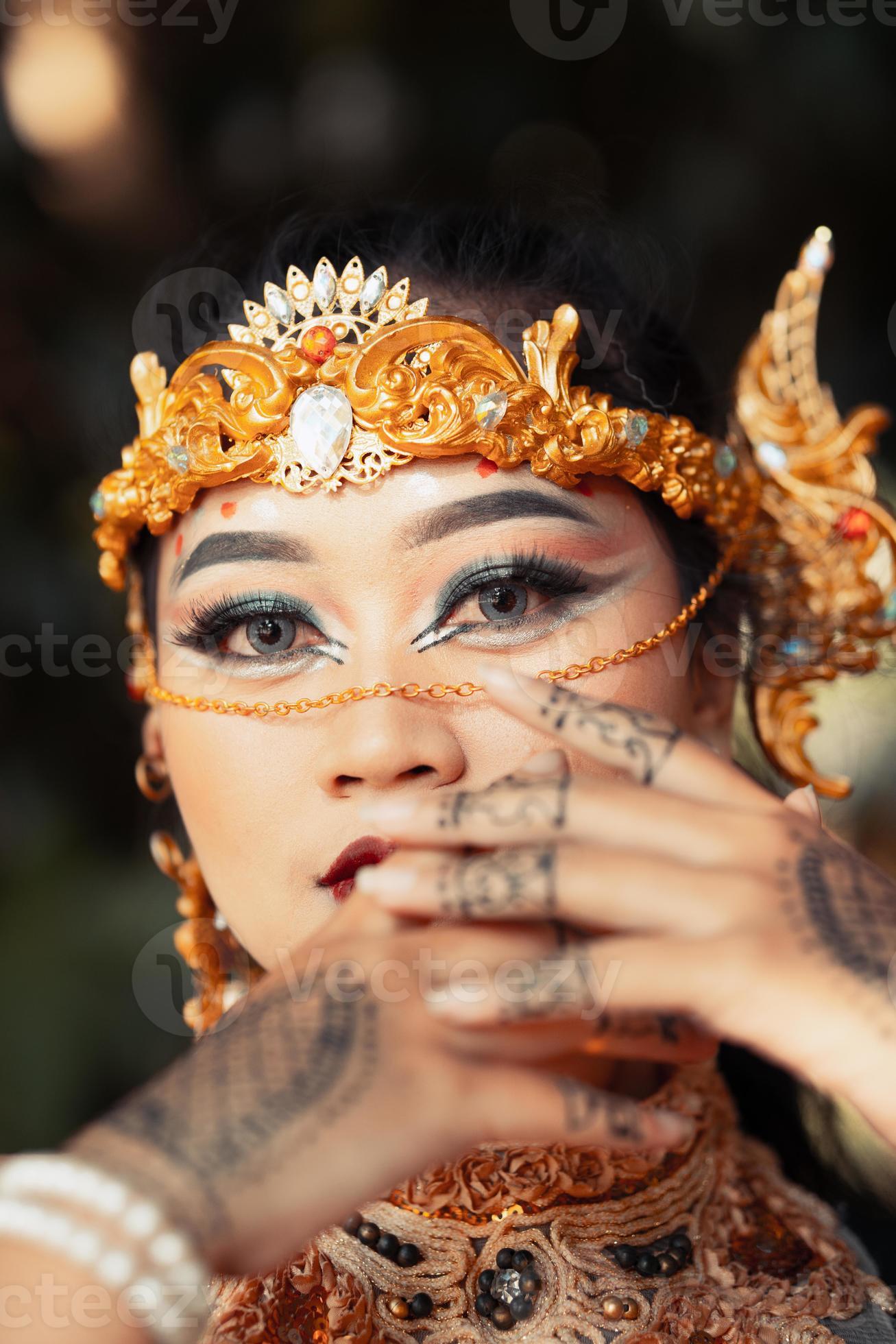 Portrait Of An Indian Woman In Makeup And Tattoos On Her Hands While