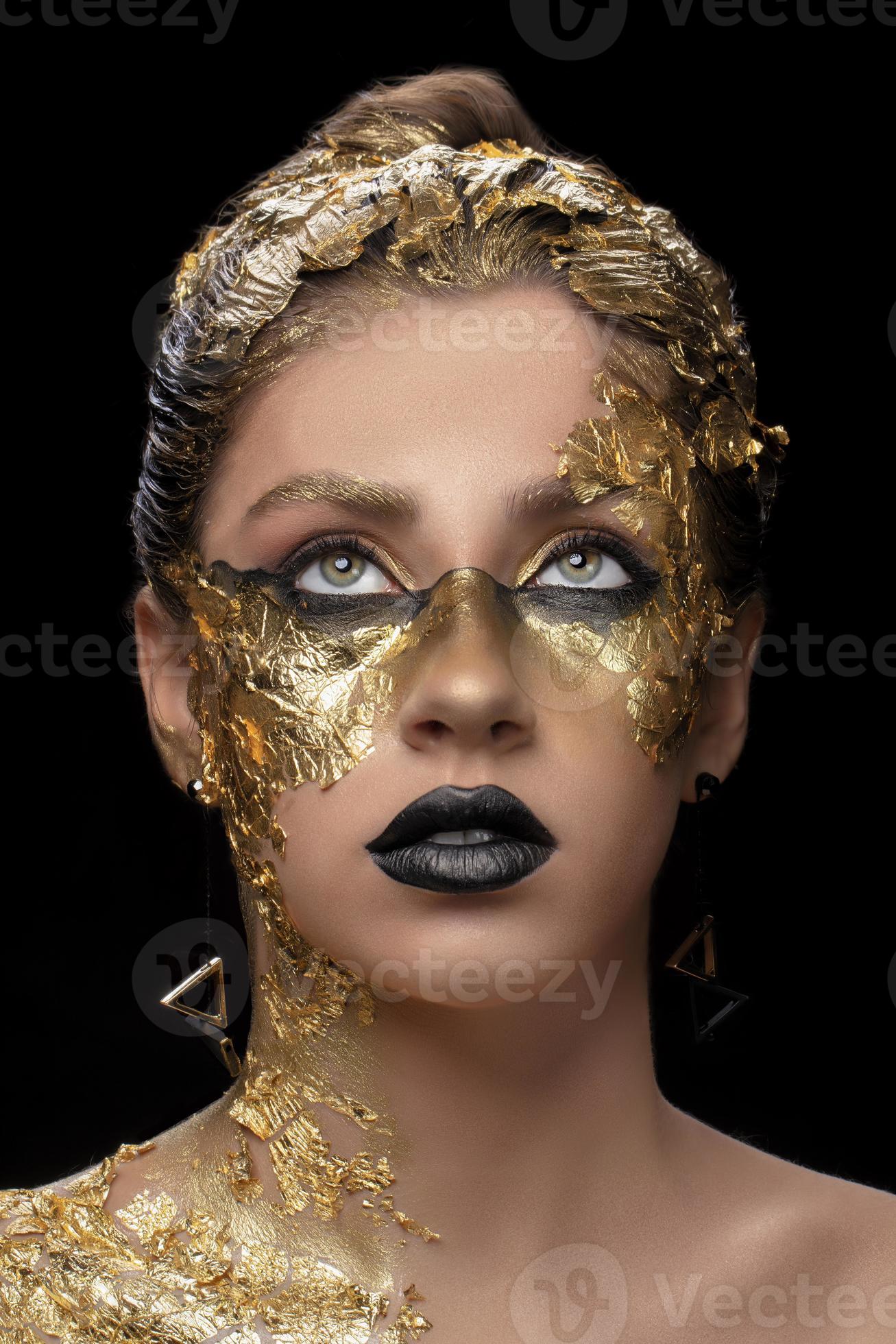 Closeup Portrait Of Beautiful Young Woman With Golden Foil On Face