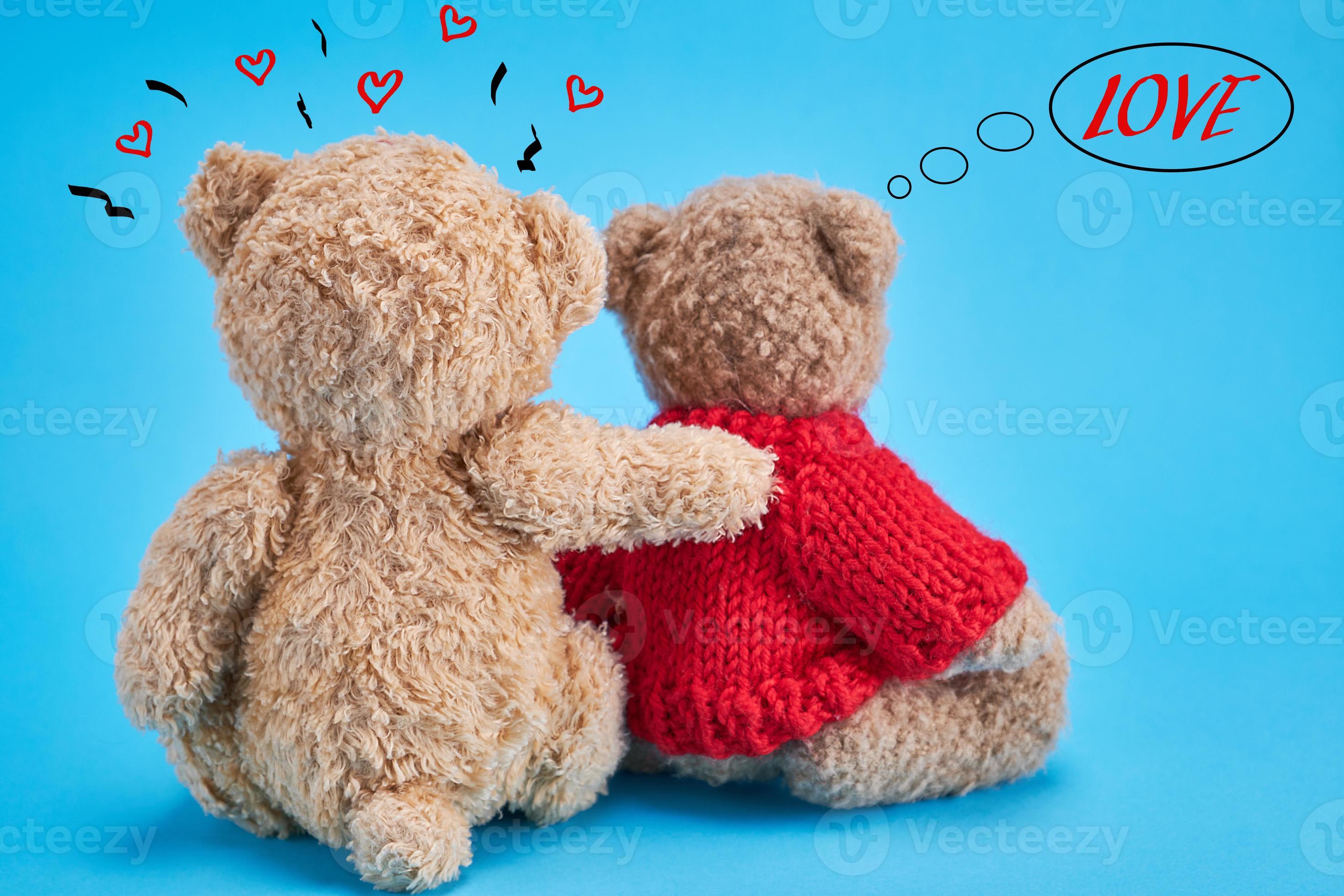 Two Plush Teddy Bears Sit Back Hugged On A Blue Background 19162032