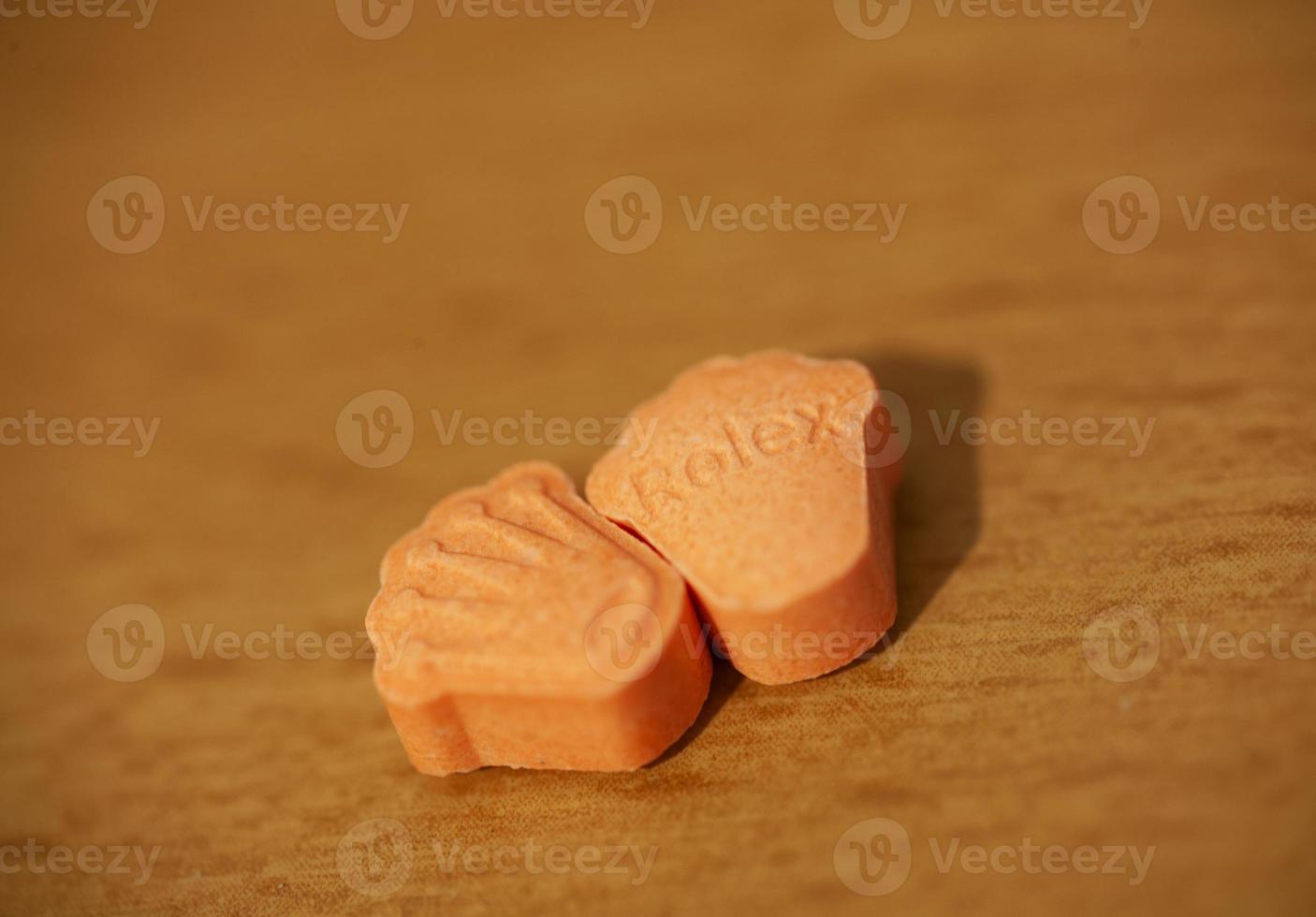Orange pills with mdma ecstasy dope rolex drug close up background fine art in high quality ...