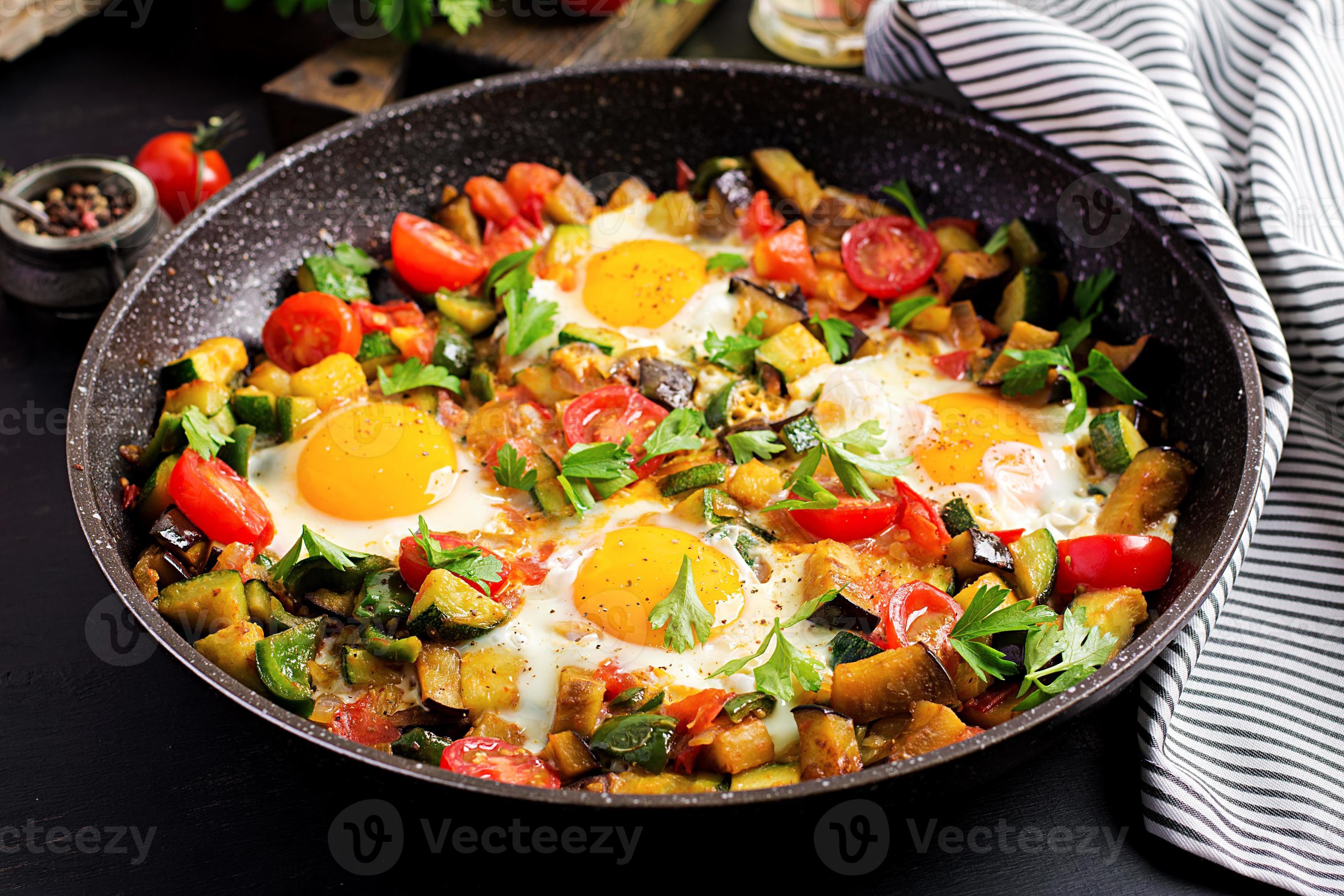 Late breakfast - fried eggs with vegetables. Shakshuka. Arabic cuisine ...