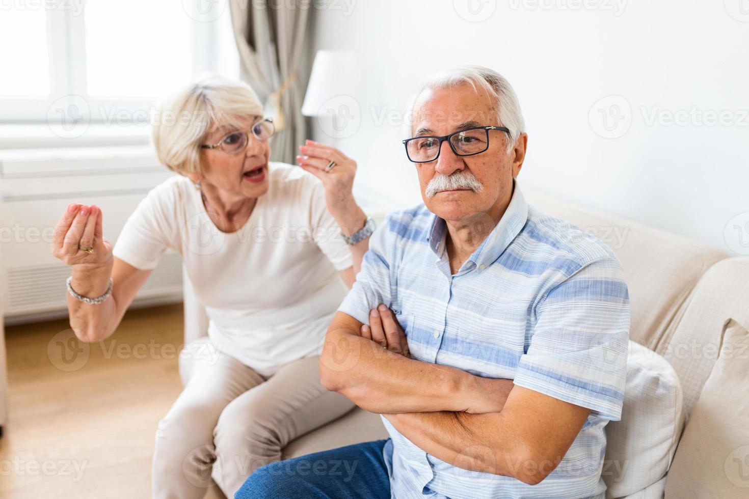 Angry elderly woman arguing with her husband. Senior couple having ...