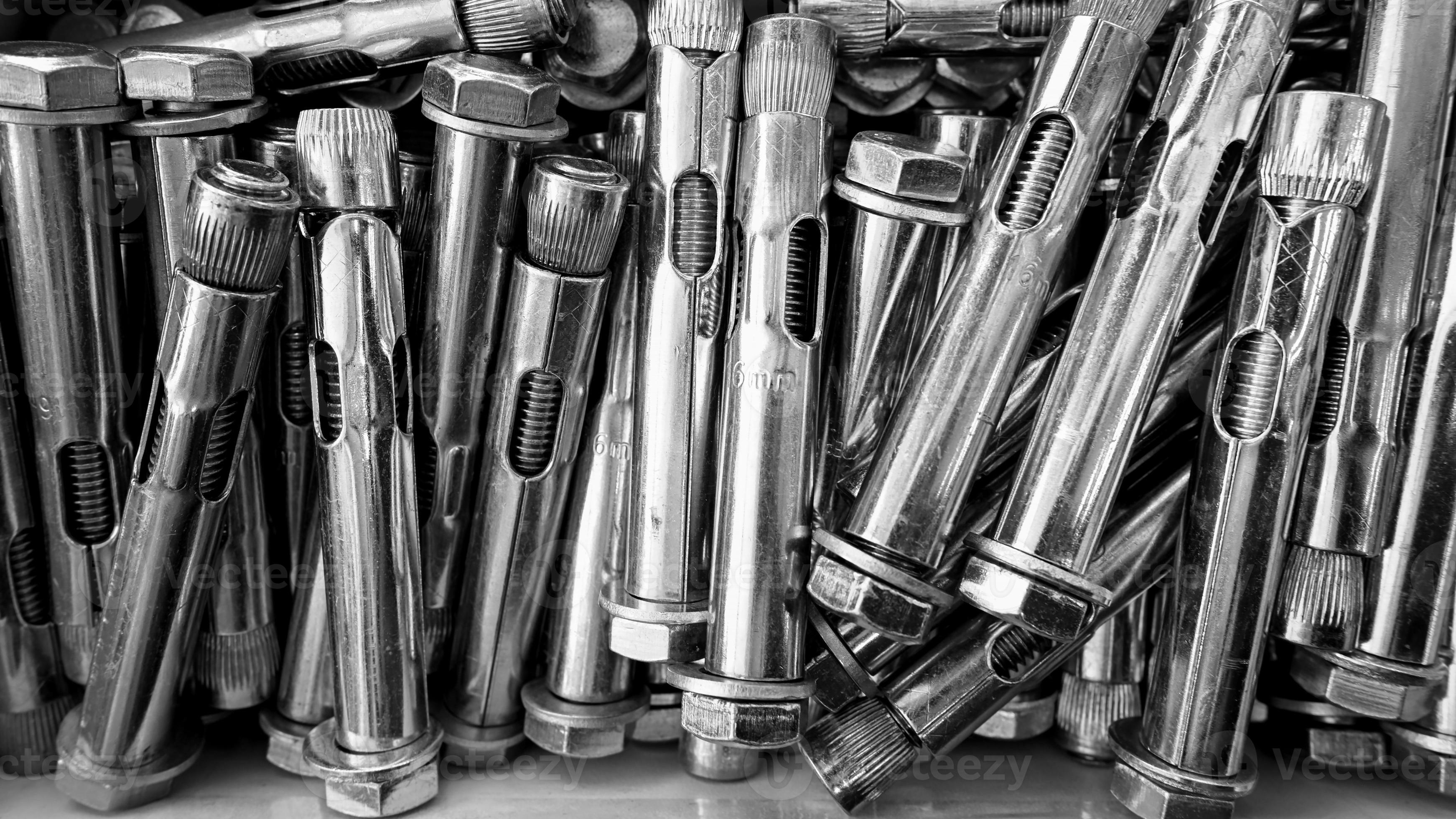 Anchor bolts. Building background for design. A set of bolts, nuts, metal fasteners. Assortment ...