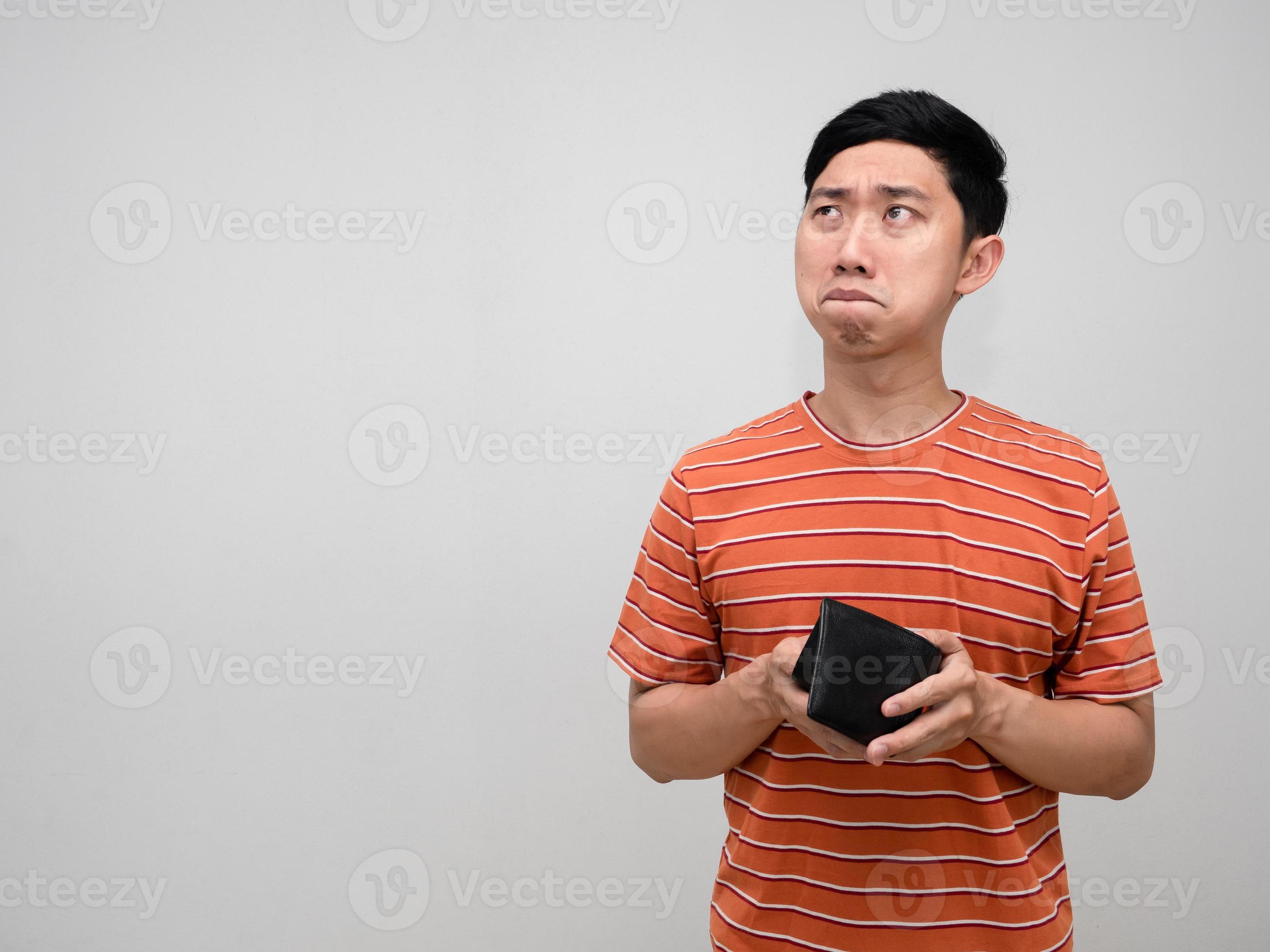 Asian man orange striped feels sad with no money in wallet isolated,Poor man unhappy about not ...