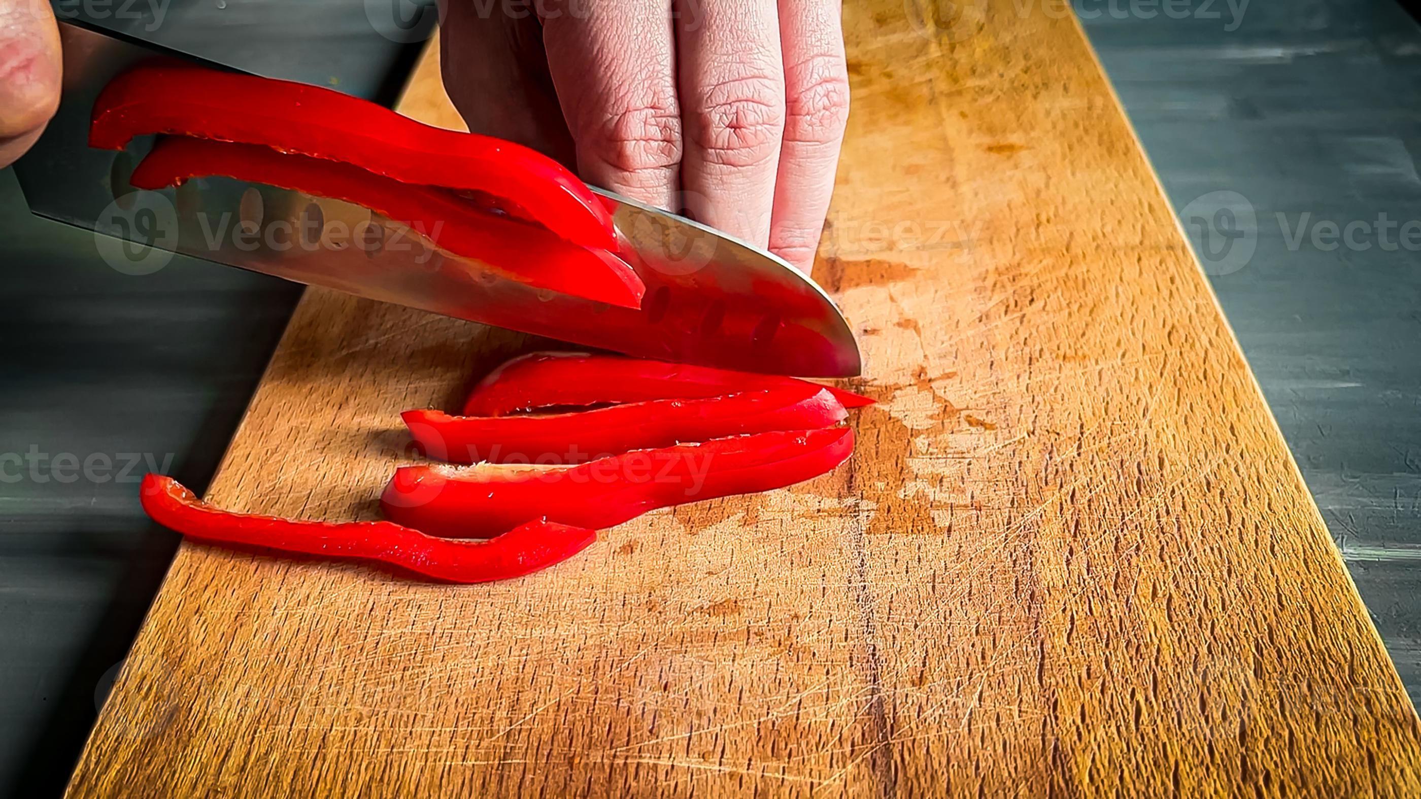 slicing red pepper. hands holding pepper 19876795 Stock Photo at Vecteezy