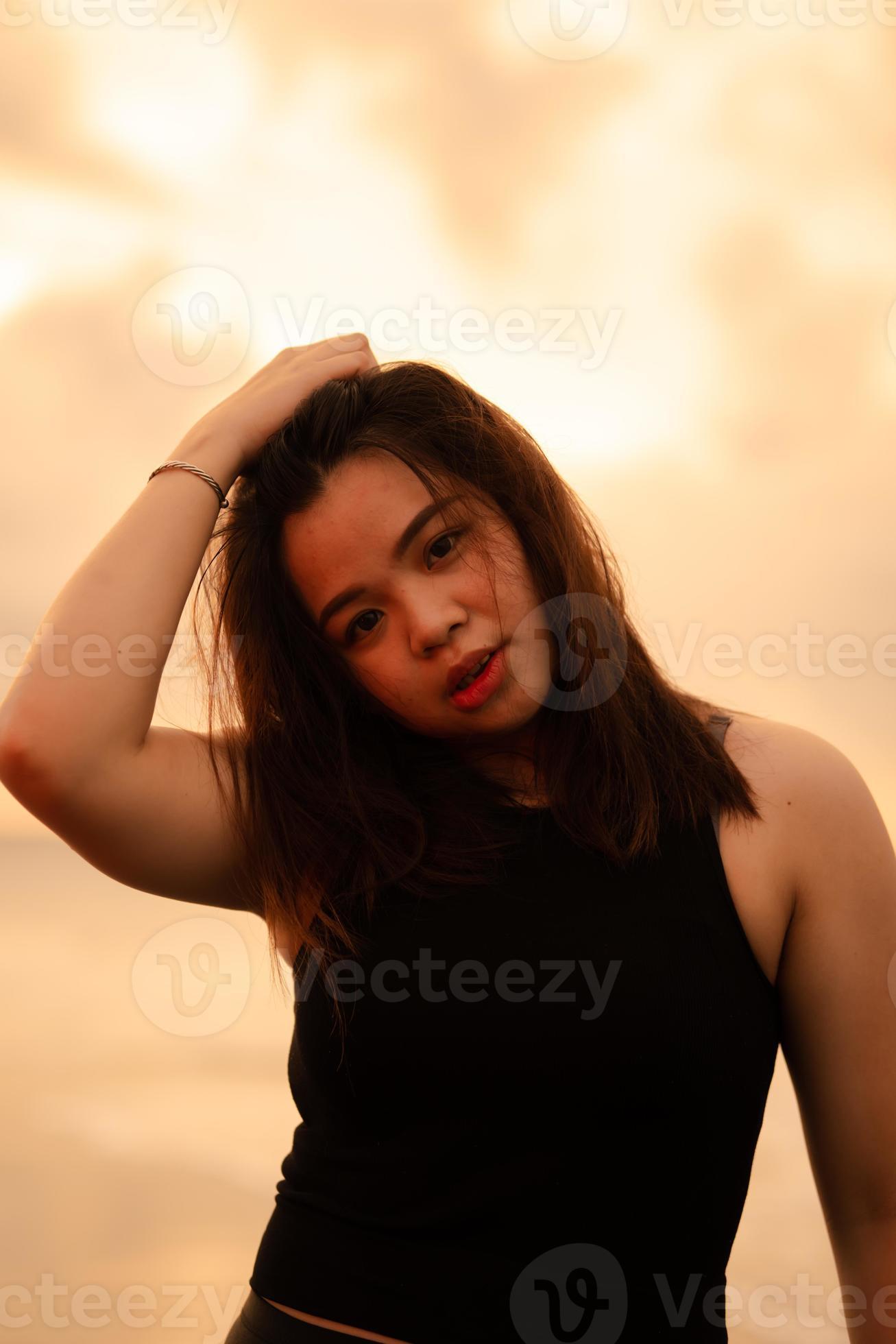 un asiático adolescente quien es posando sexy por participación su cabeza y negro pelo en el ...